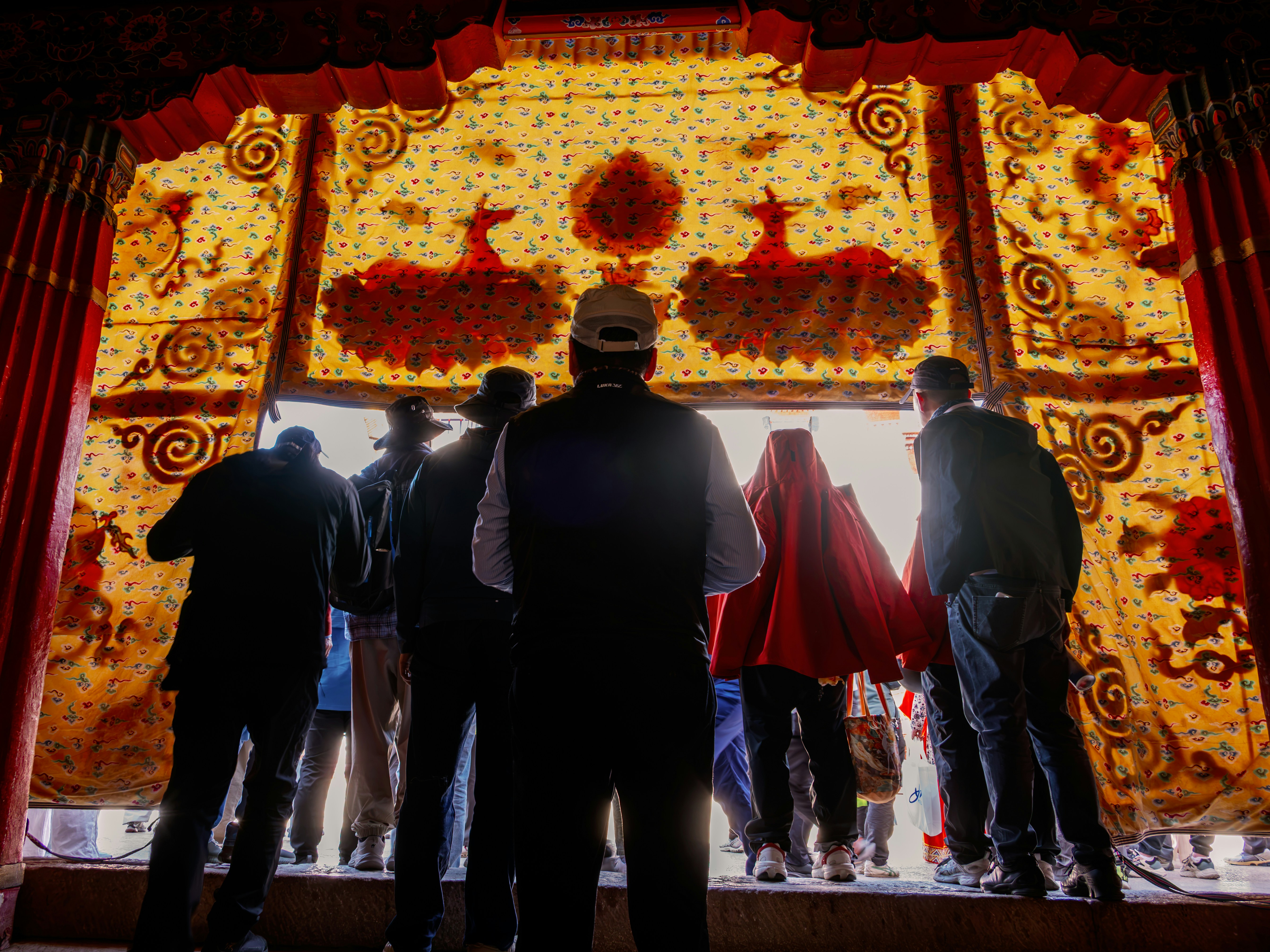 Backlit Threshold: A Crowd Ready to Enter a Sunlit Exhibit