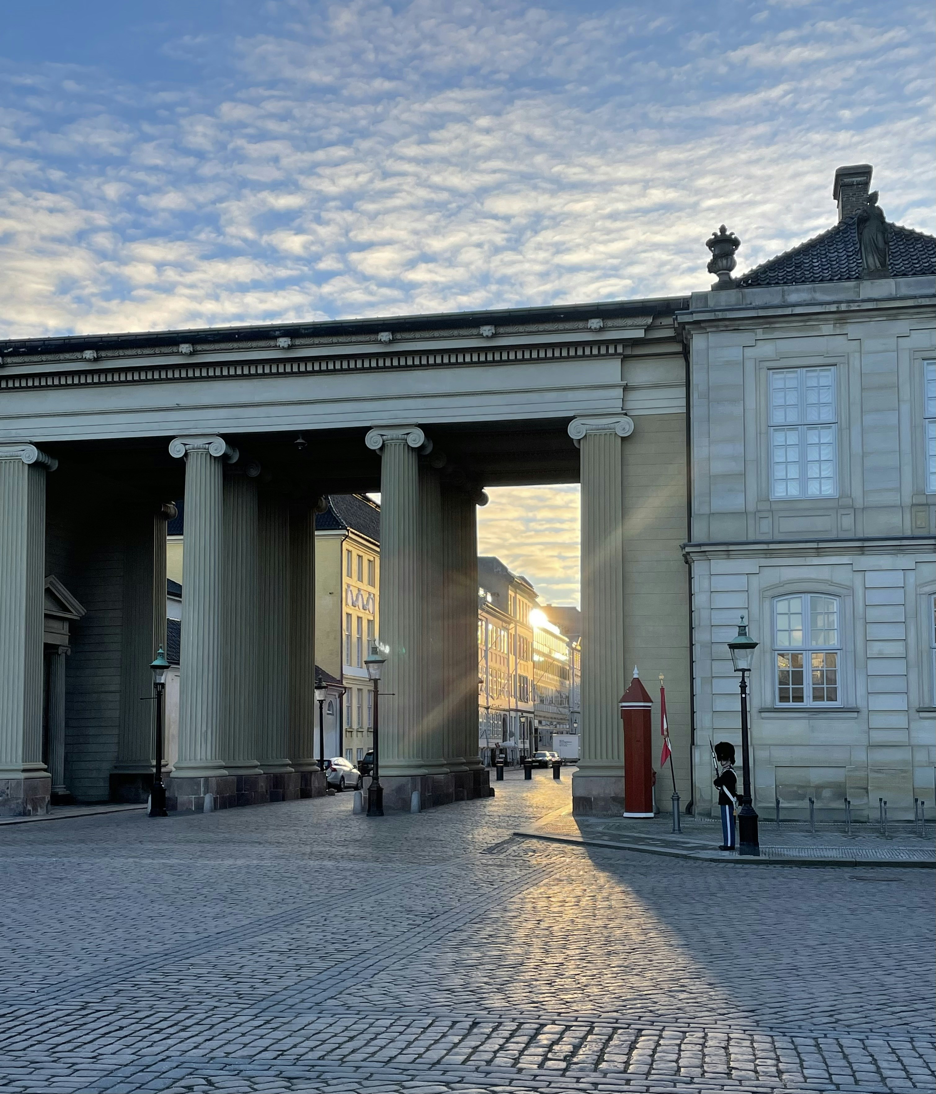 Columns, Light, and Cobblestones: Sunburst Through the Arcade