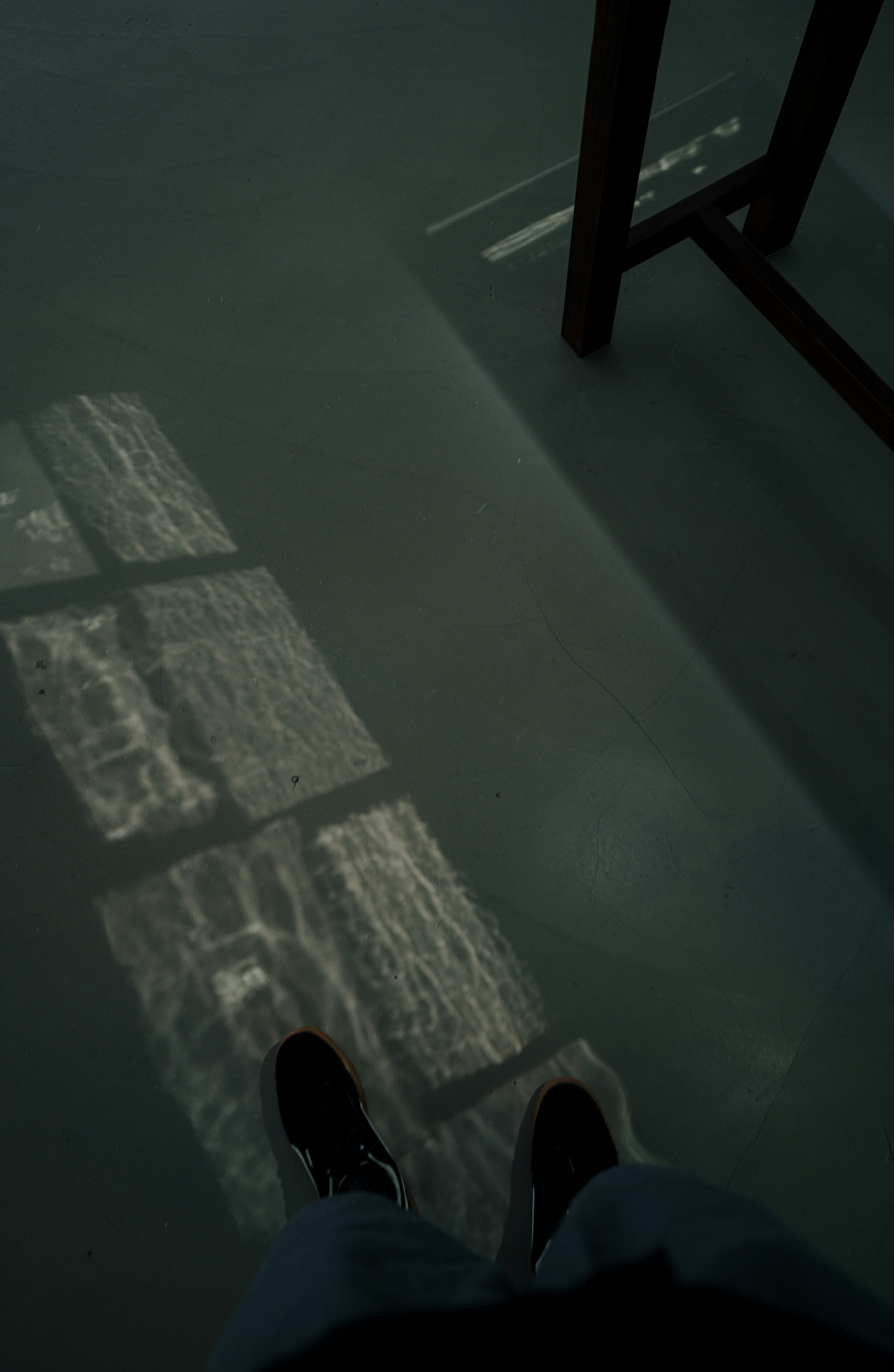 Shadowed Steps: Footwear and Window Light on a Quiet Floor