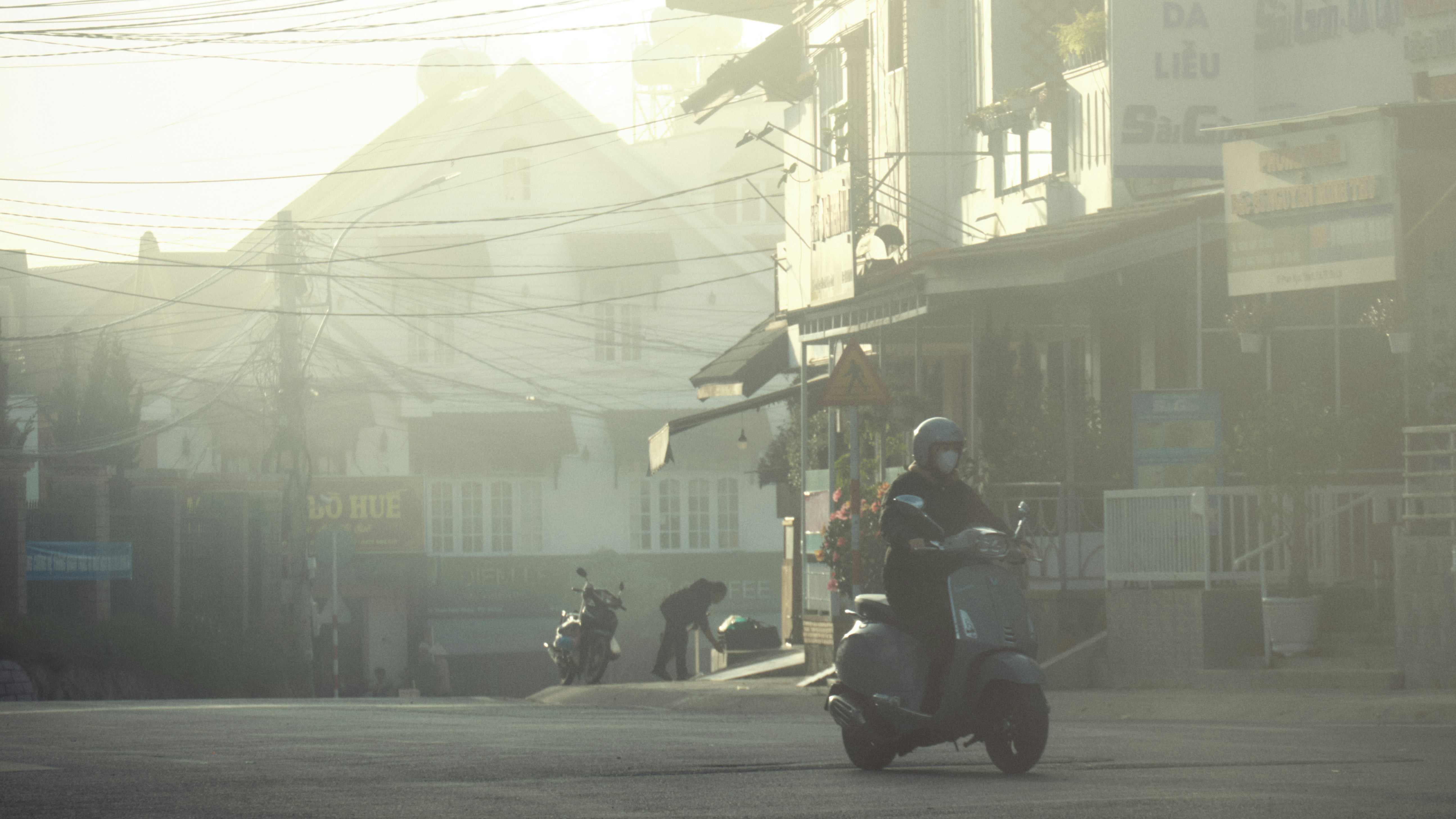 Dusty Dawn Ride: A Scooter Pauses at the Edge of Town