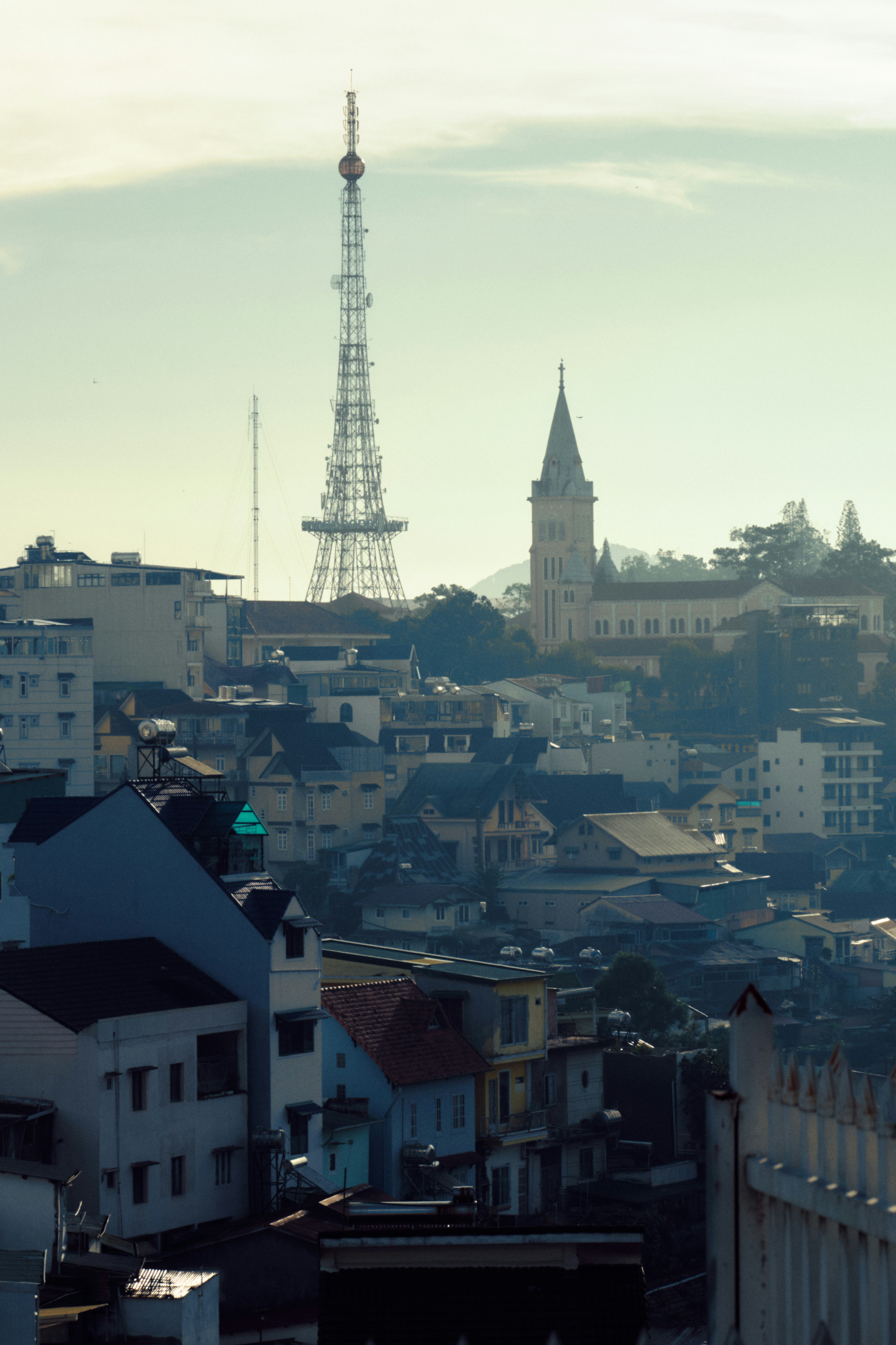 Urban Ridge: Distant Communications Tower Above a Quiet Cityscape