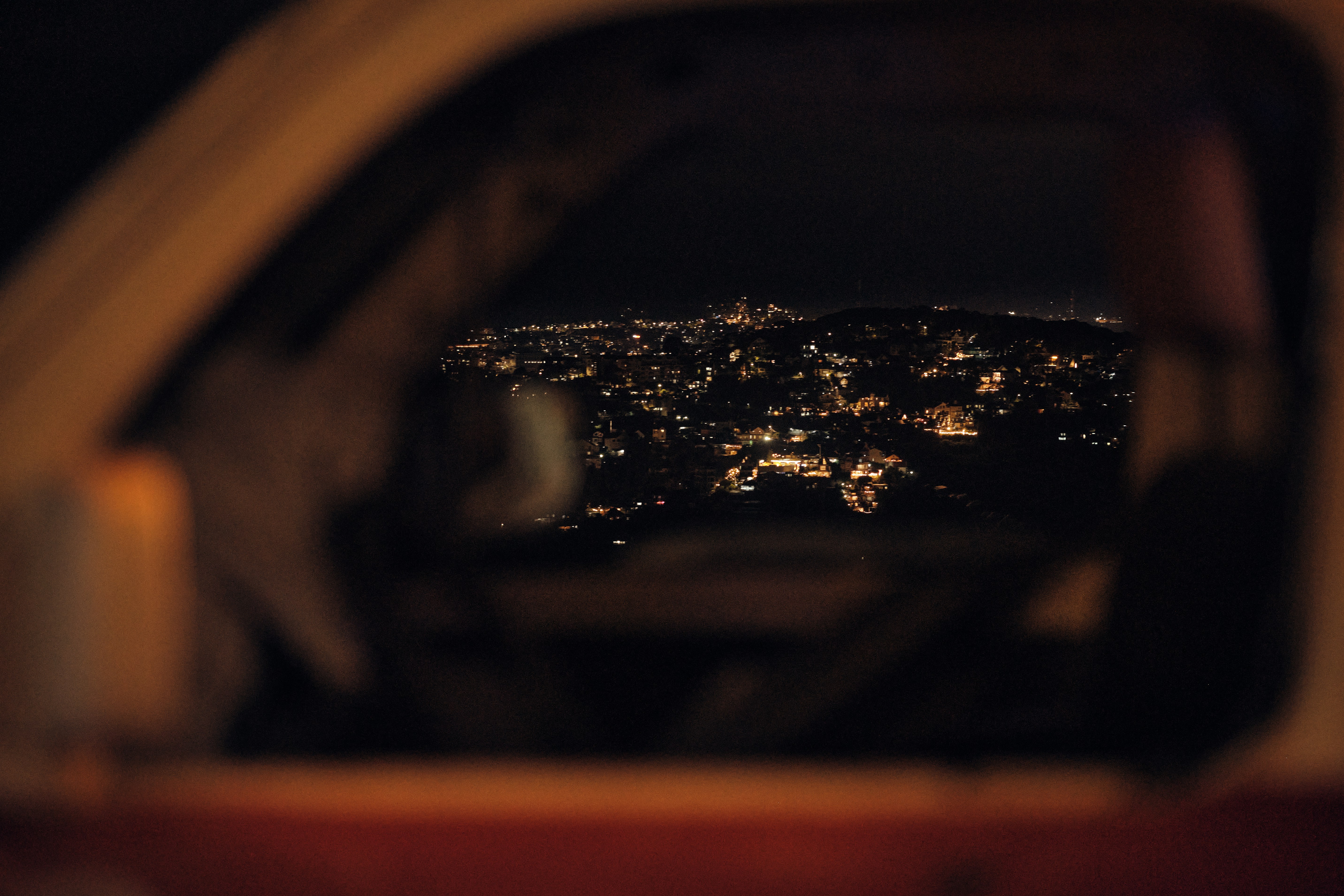 City Lights Framed by a Car Window at Night