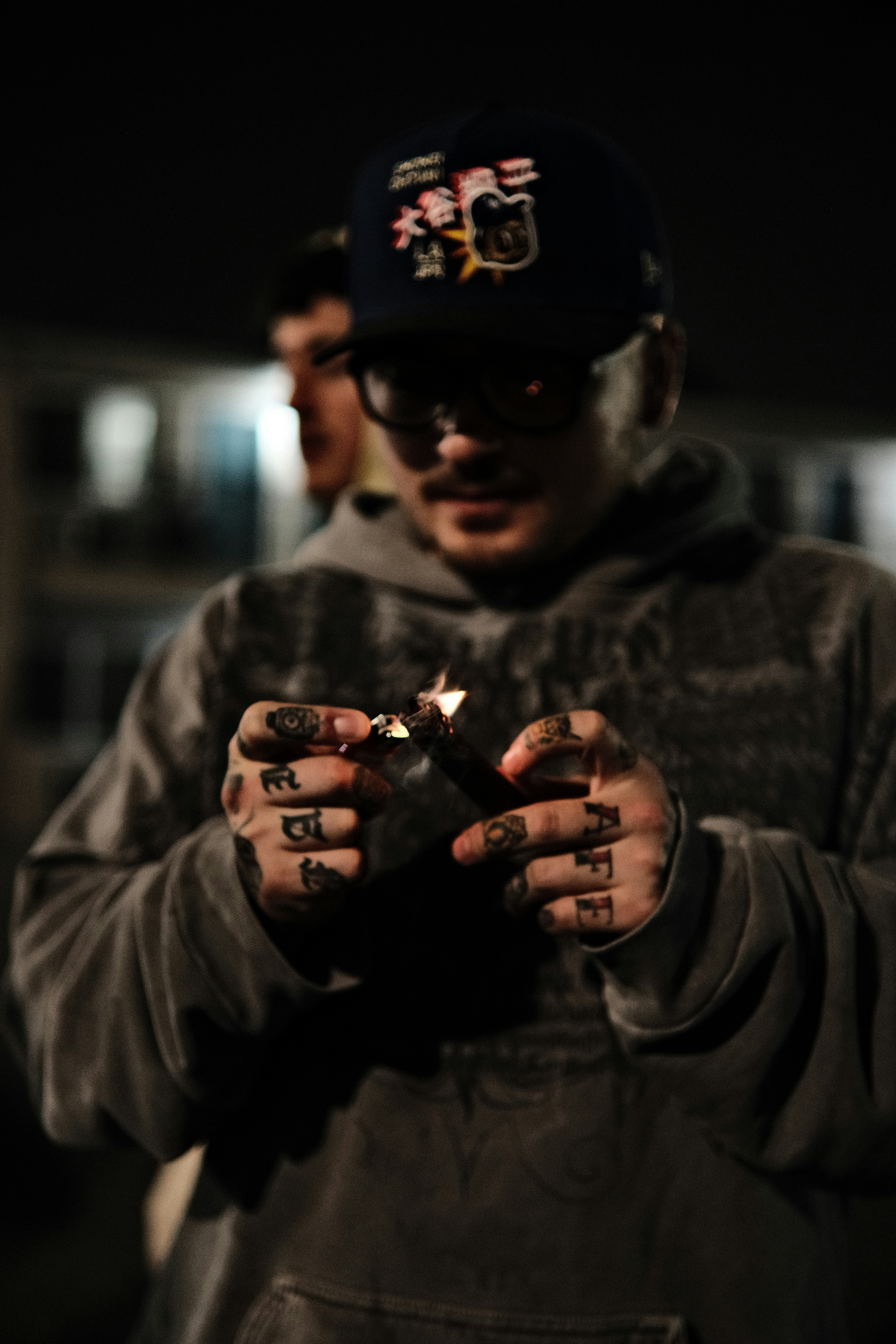 Midnight Sparks: Hands, Flame, and Tattooed Focus