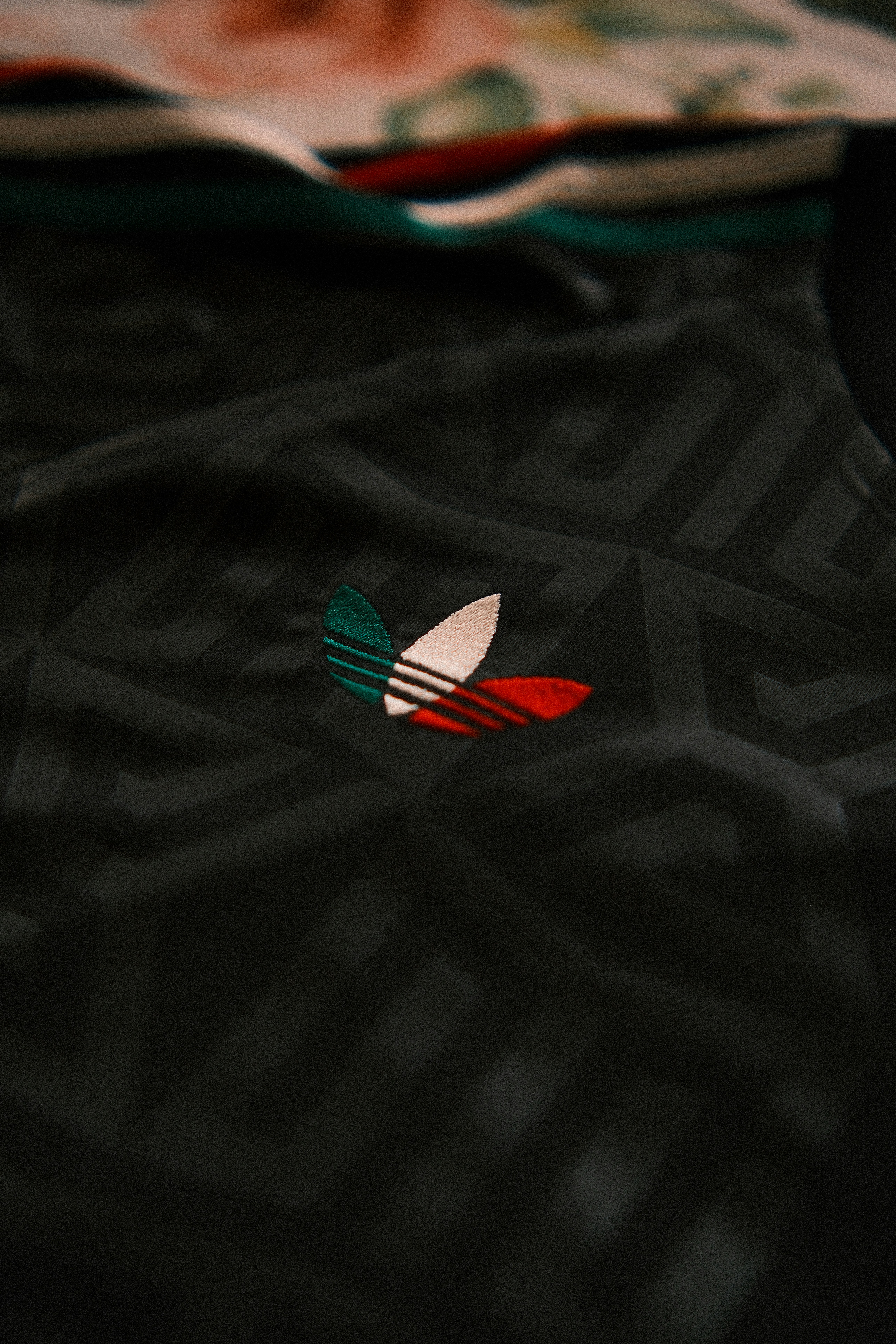 Embroidered Adidas Logo Nestled in Dark Geometric Fabric