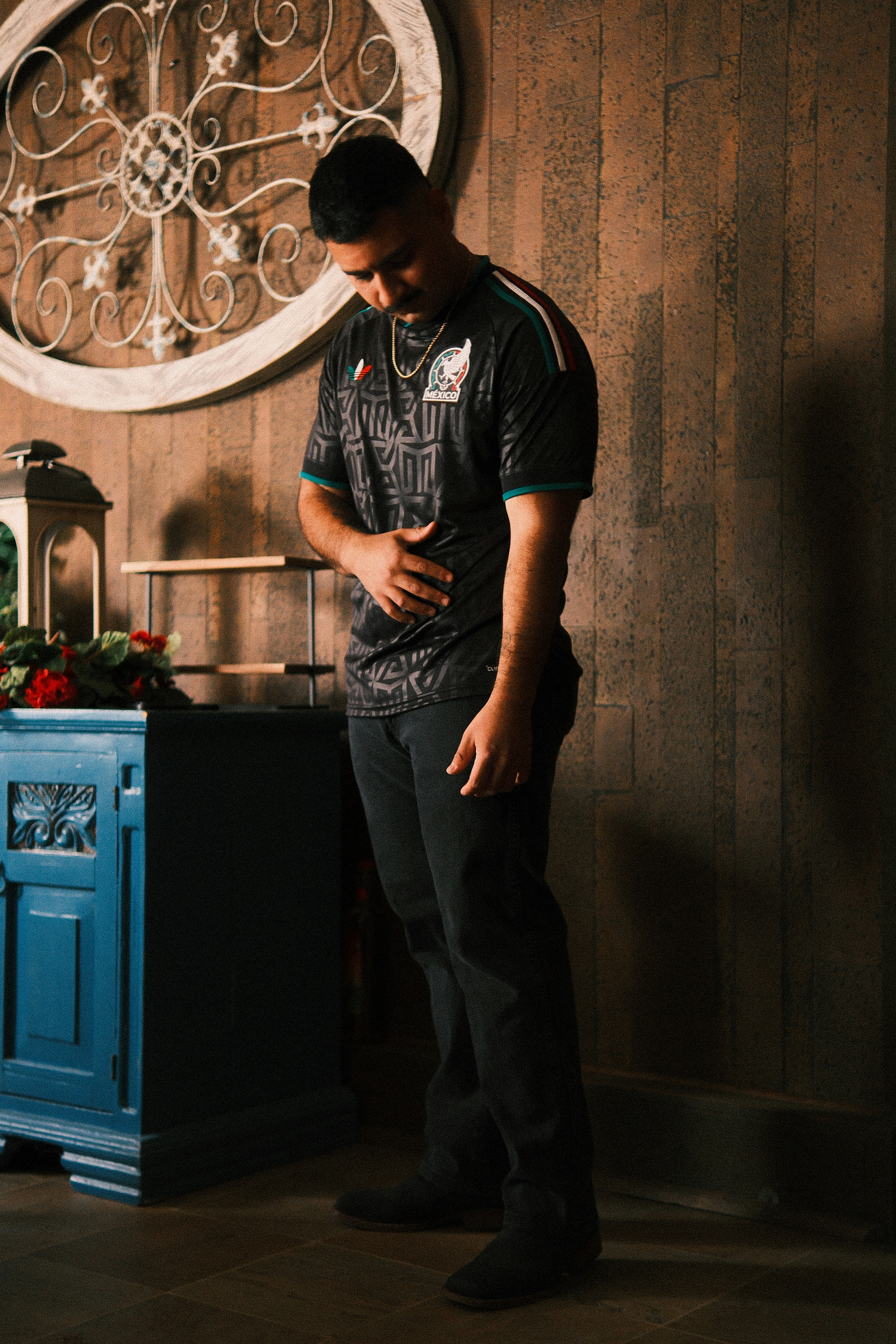 Silhouetted Thought: A Quiet Moment by the Blue Cabinet