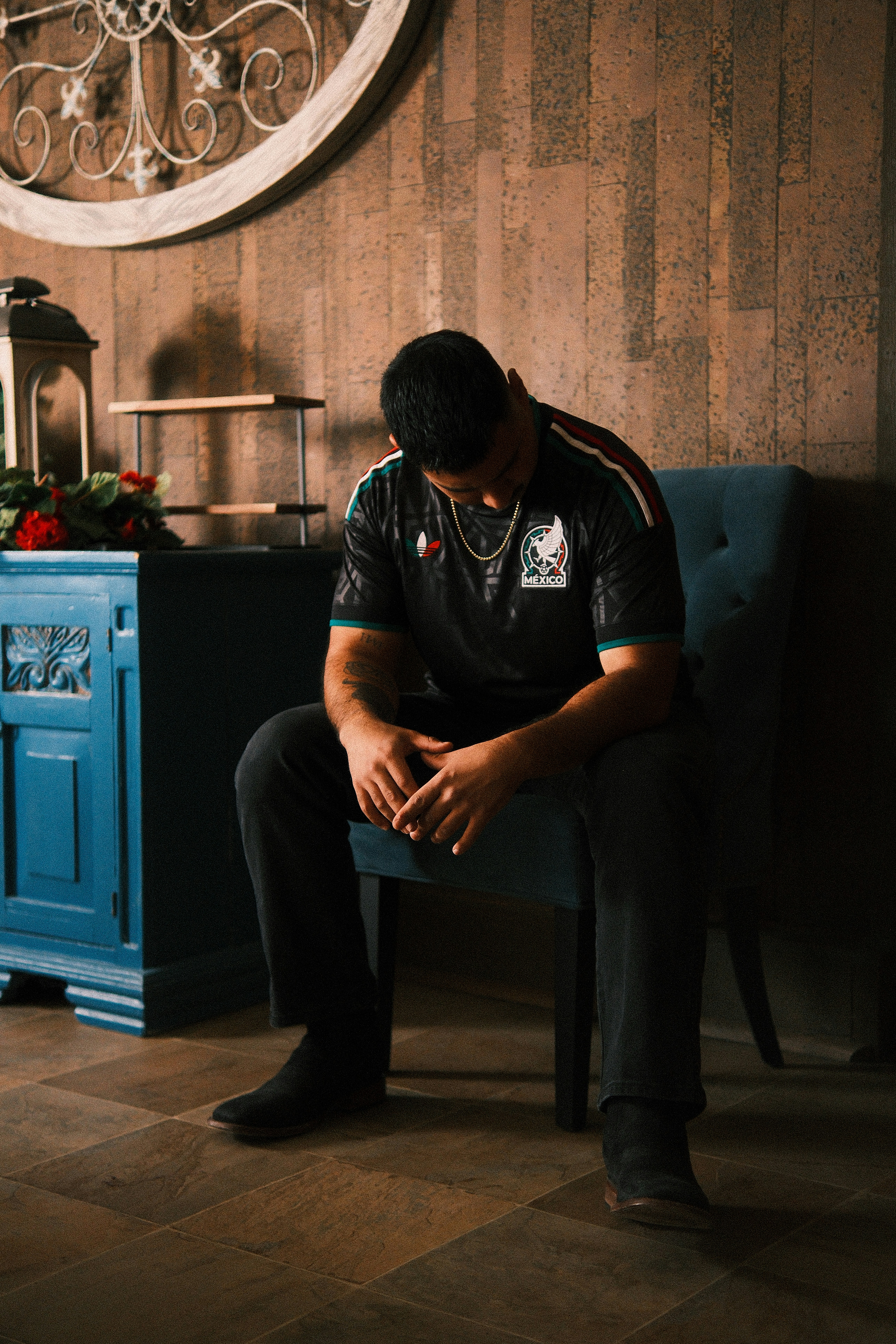 Solace in a Quiet Moment: A Man in Contemplation on a Velvet Chair