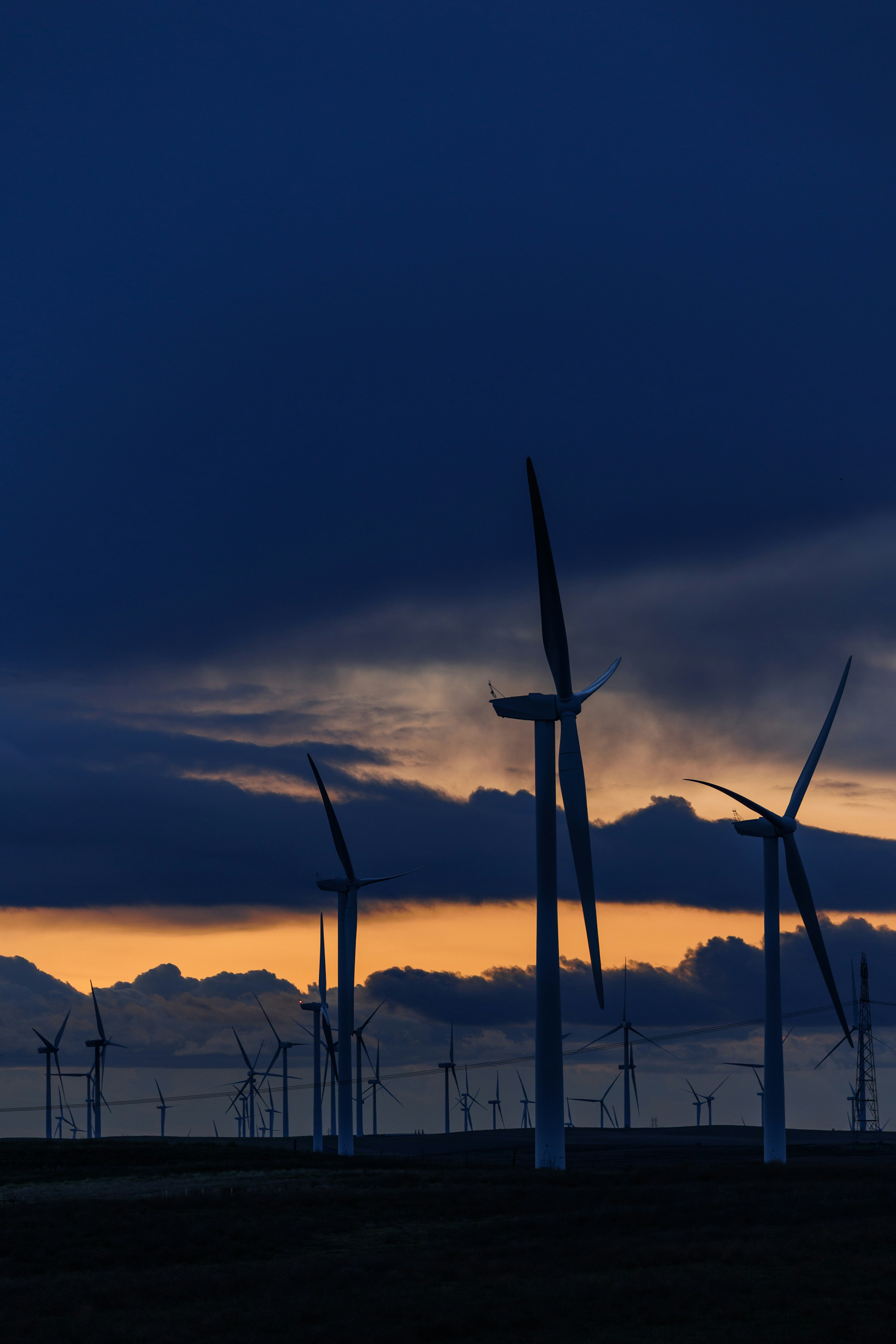Dawn Warrior: Wind Turbines Silhouetted Against a Silent Horizon