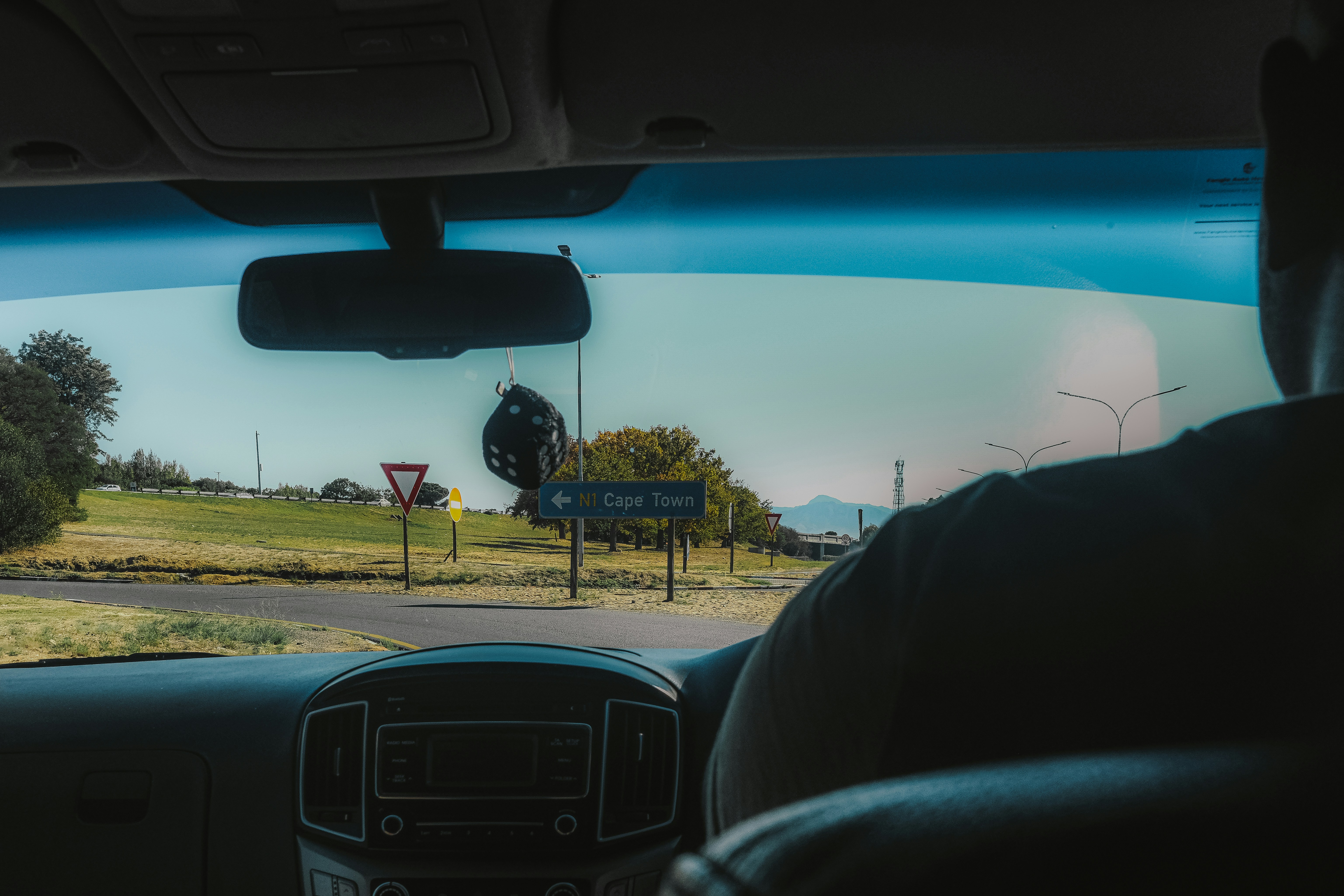 Road Sign Reverie: The View from a Car Cabin at a Roundabout