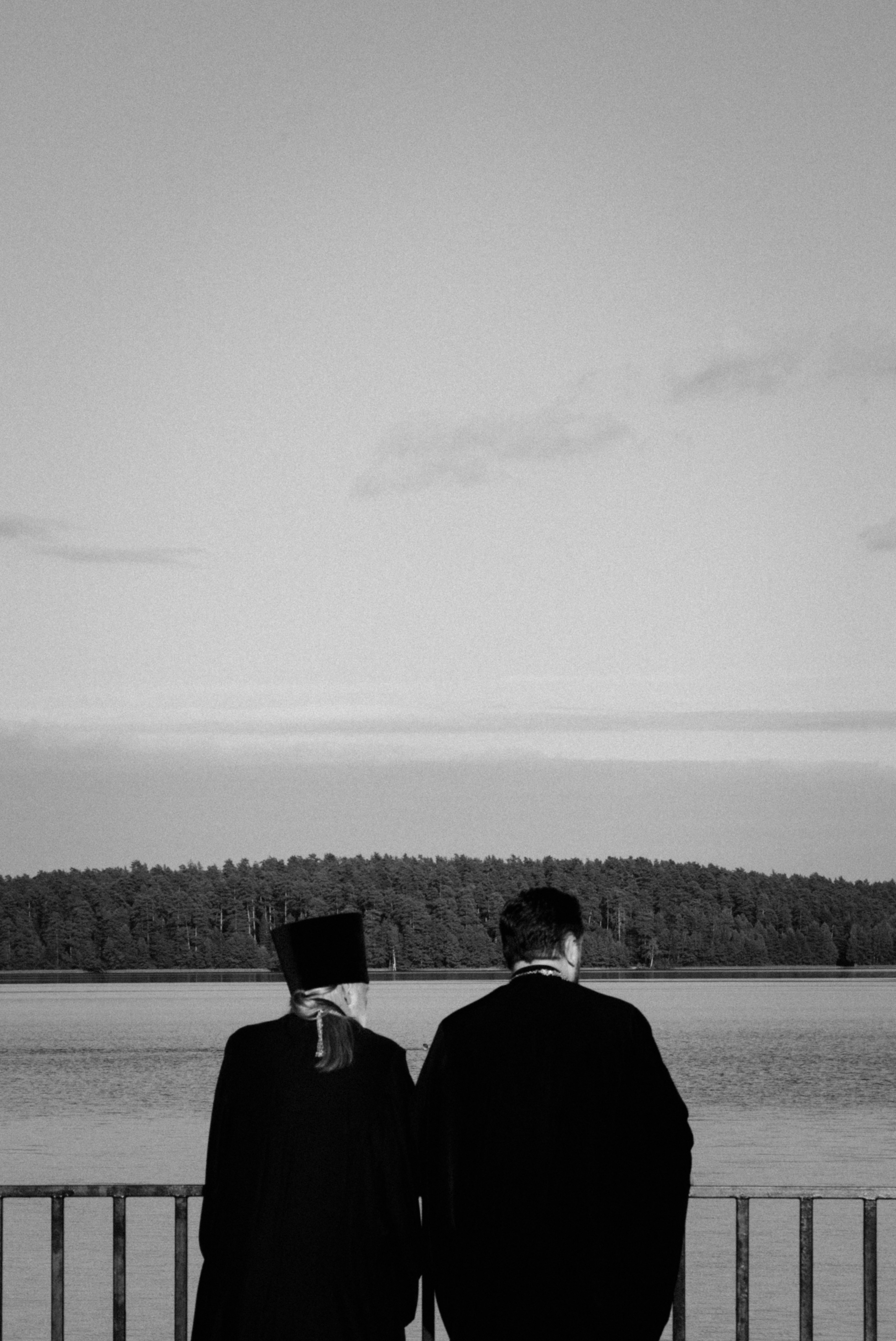 Two Figures in Silhouette by the Distant Shore