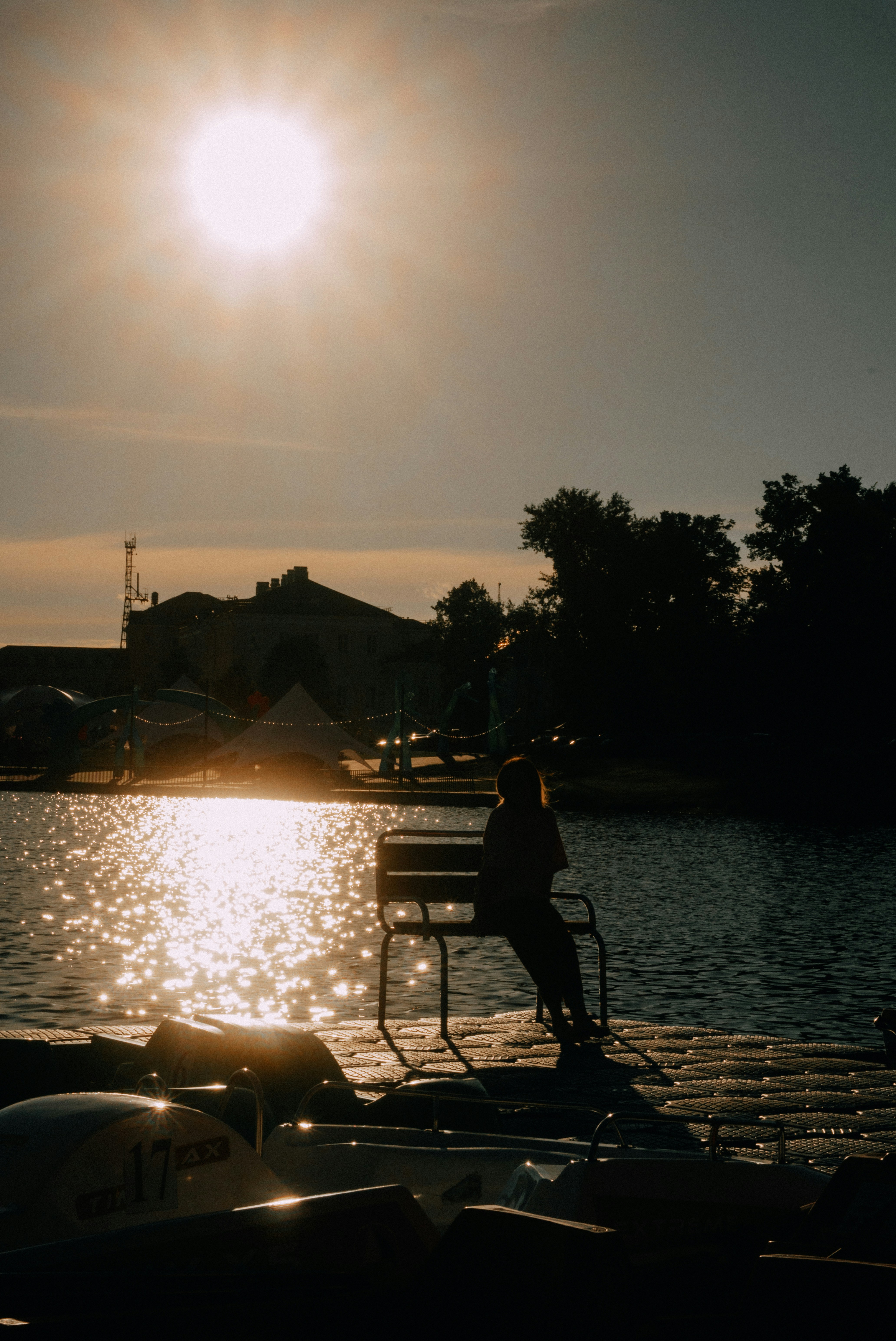 Solitary silhouette by the sunlit quay