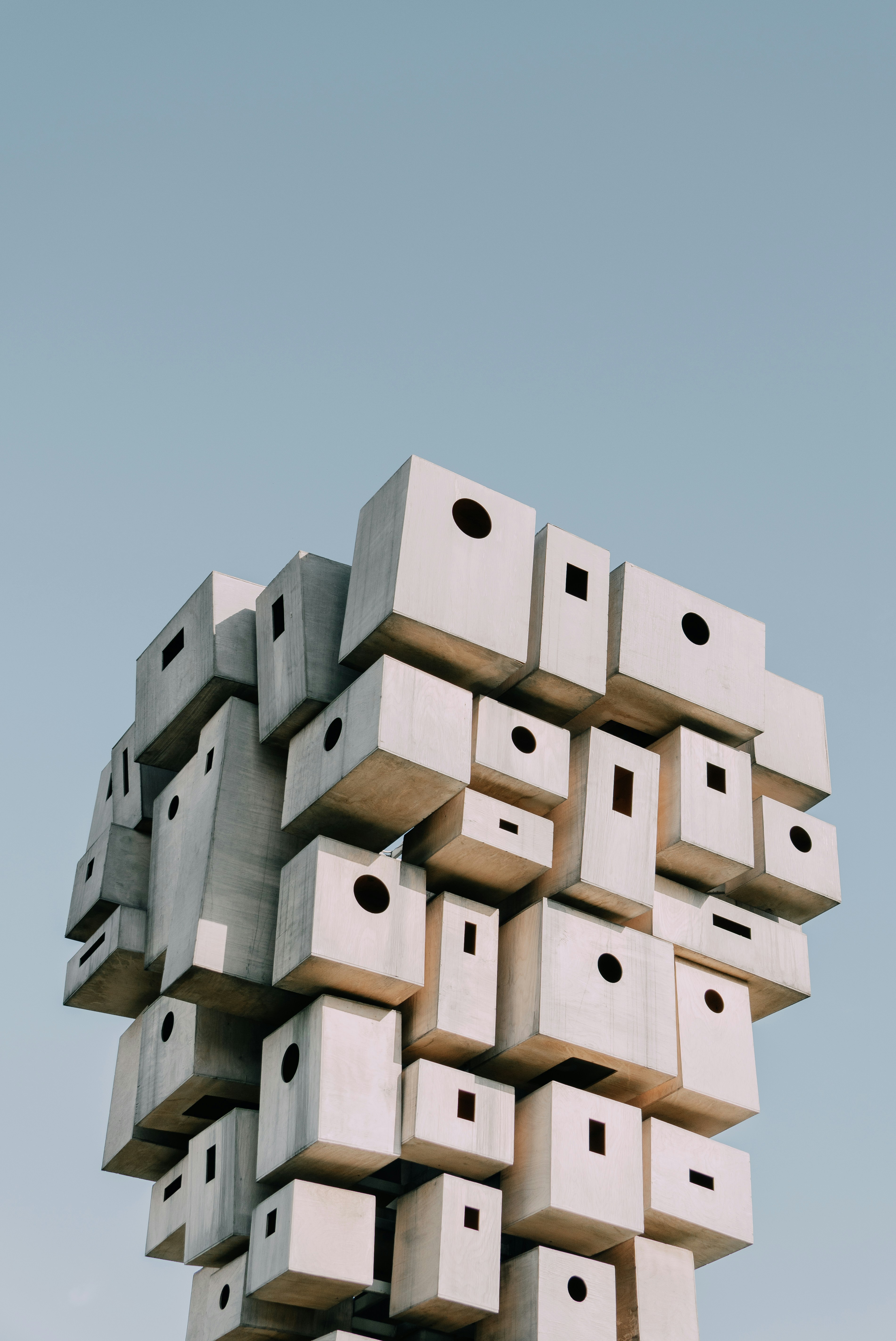Stacked Cubes of Quiet Geometry Against a Clear Sky