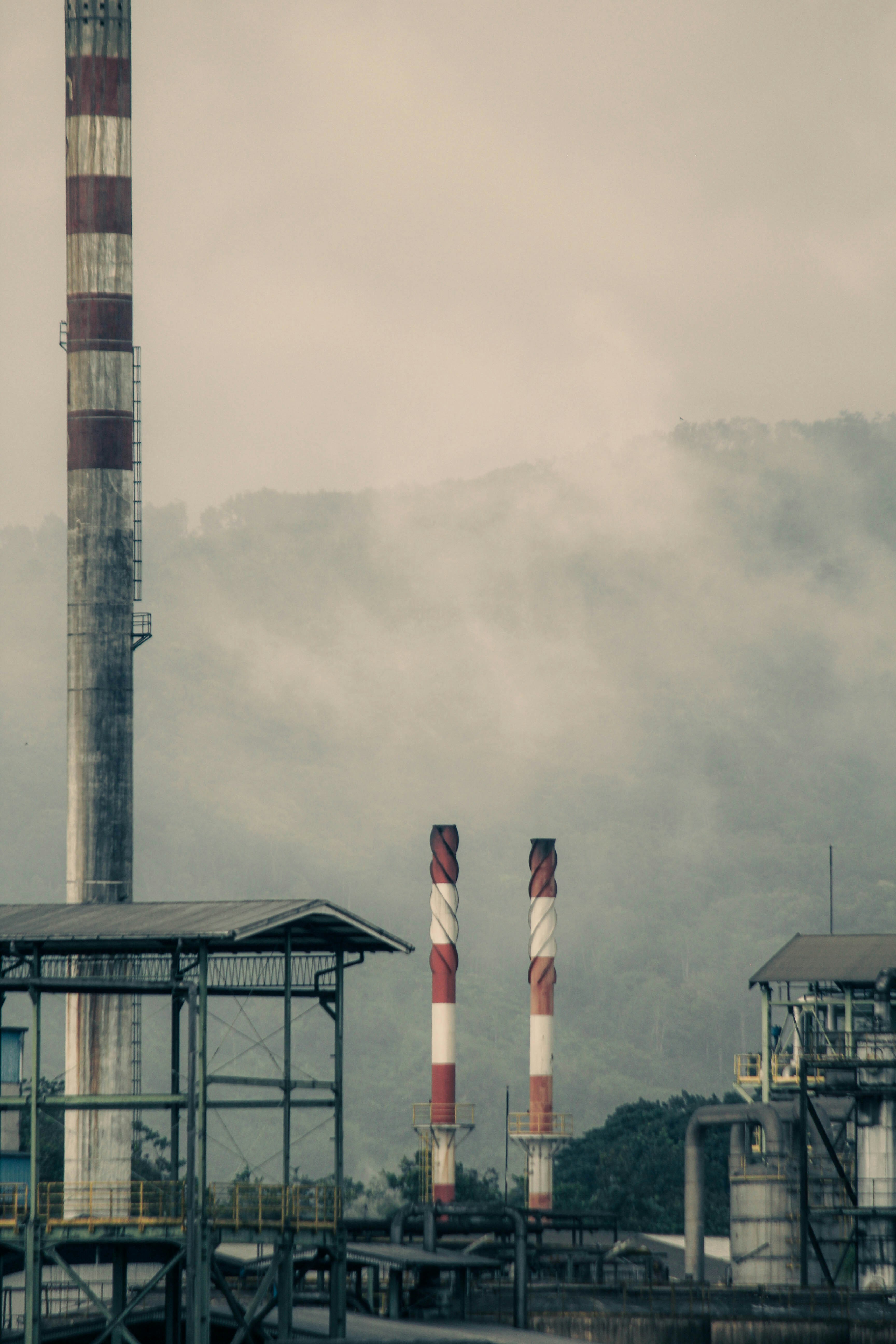 Industrial skyline mid-morning haze with striped chimneys