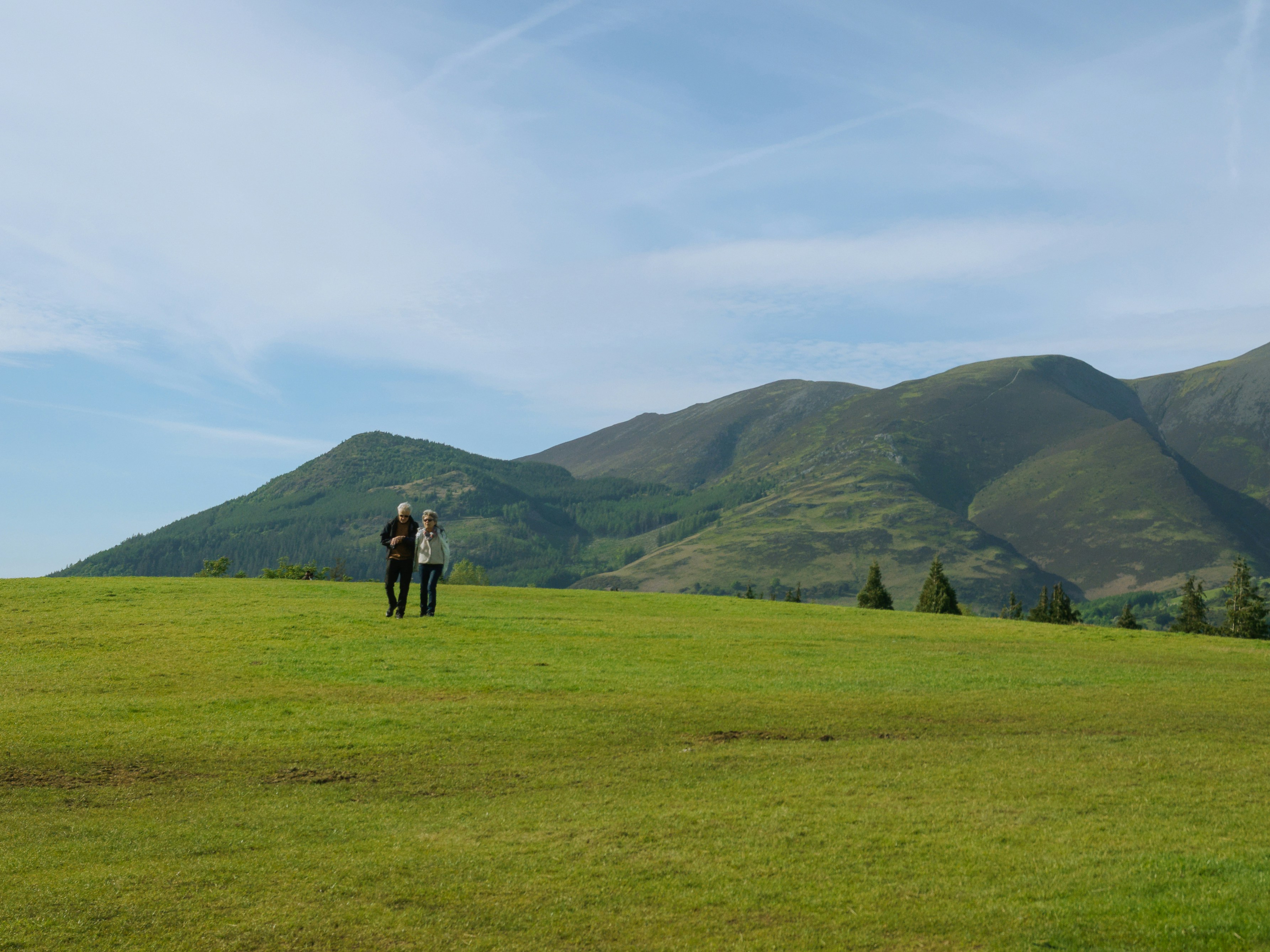 Two Hikers on a Sunlit Highland: A Quiet Panoramic Moment