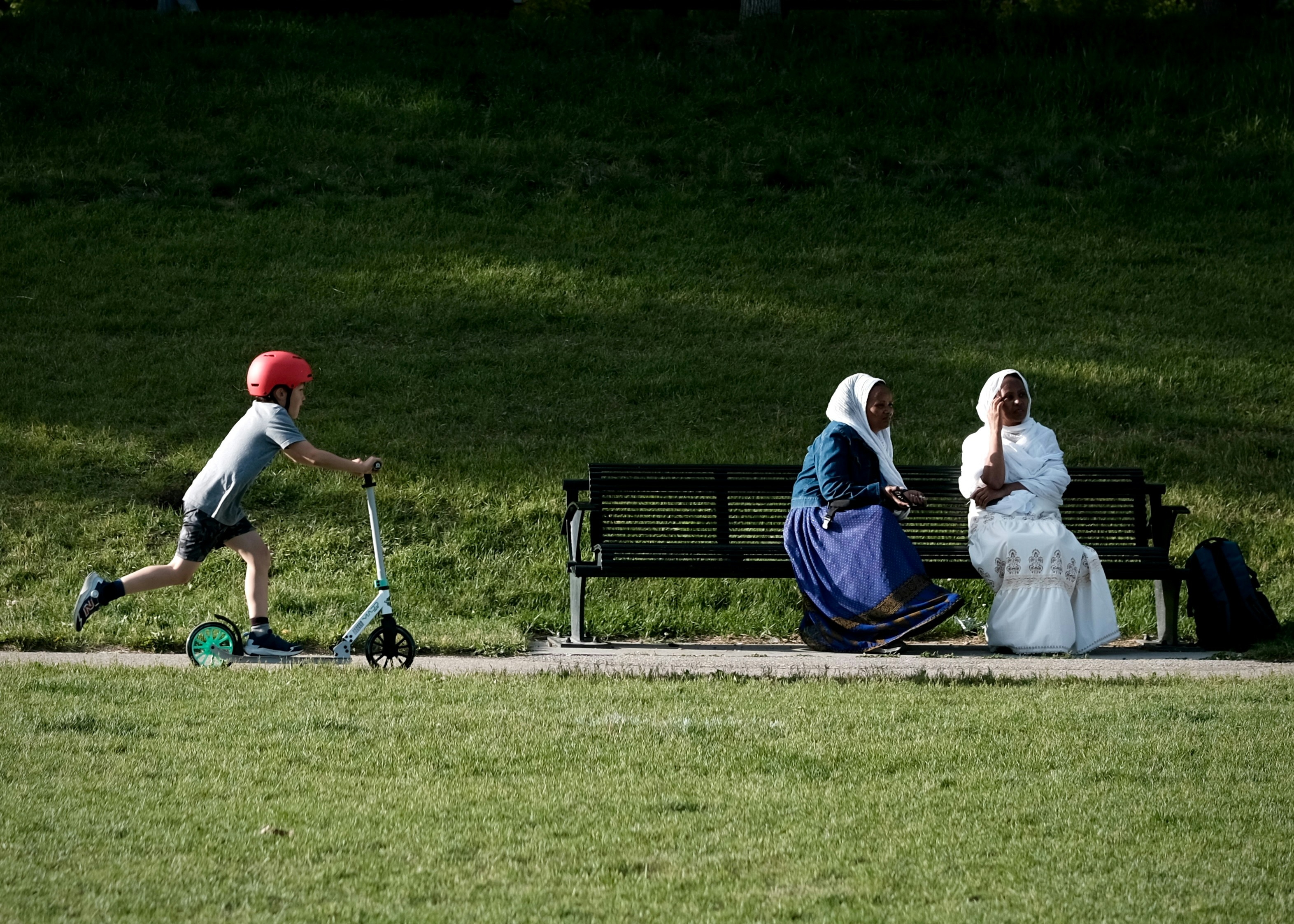 Scooter Race at Sundown: A Stretch of Park and Silent Gaze