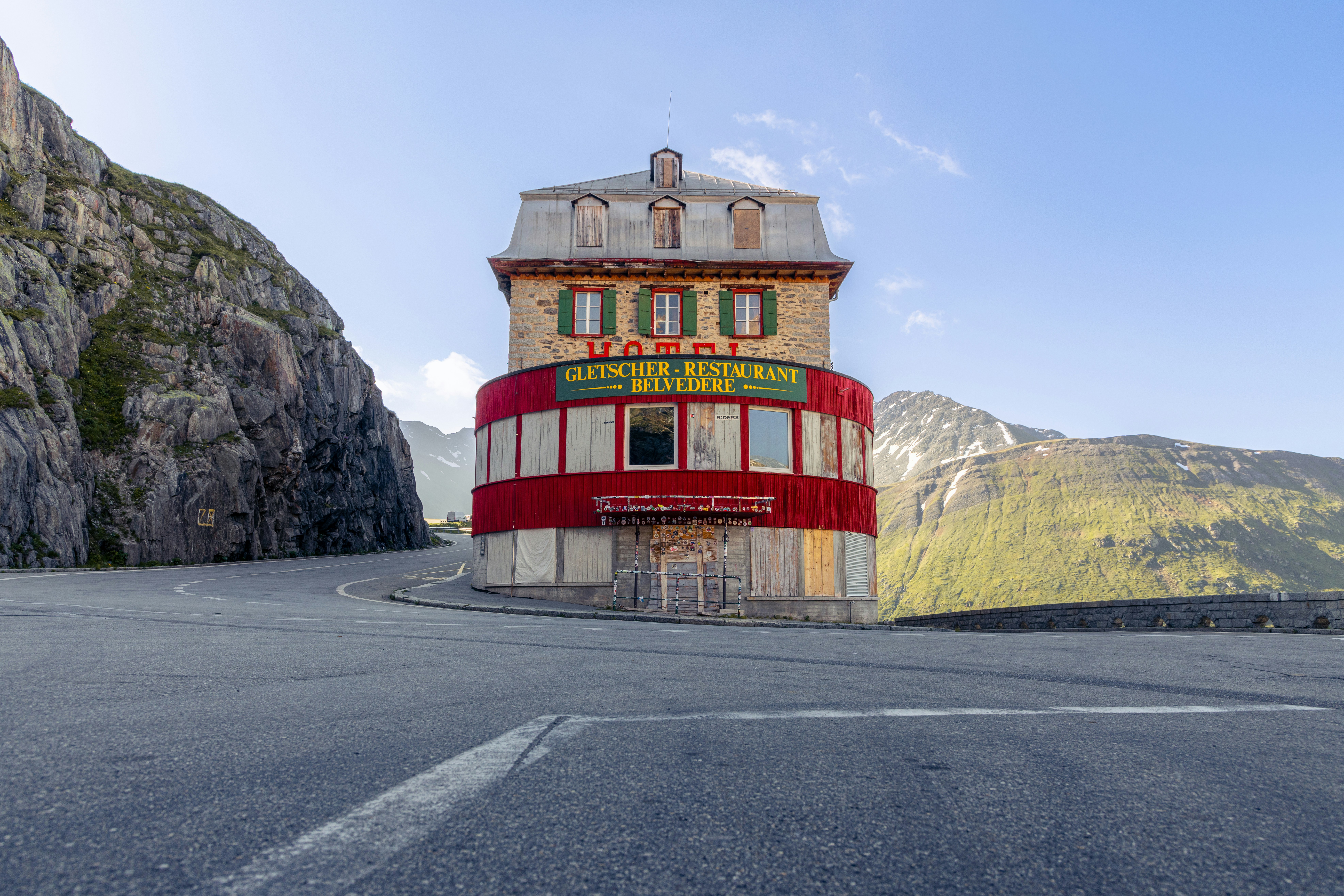 A Red-Wanded Café Rises at the Edge of the Pass