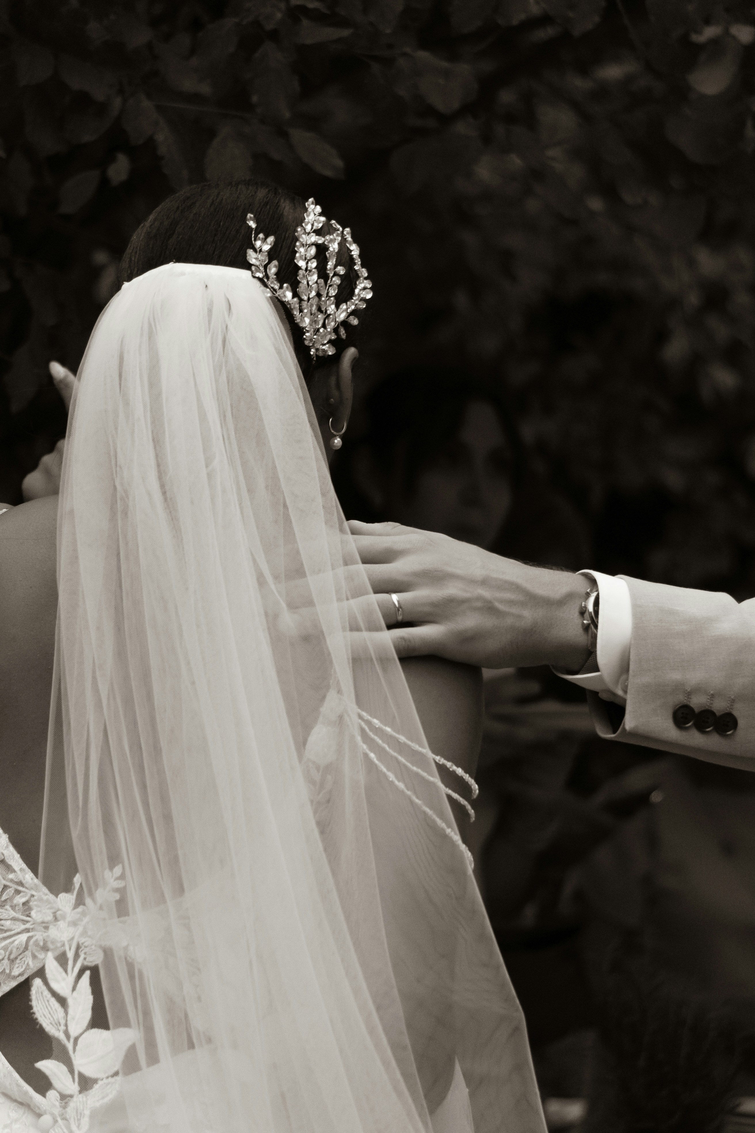 Veiled vows: a groom's touch on a bridal veil