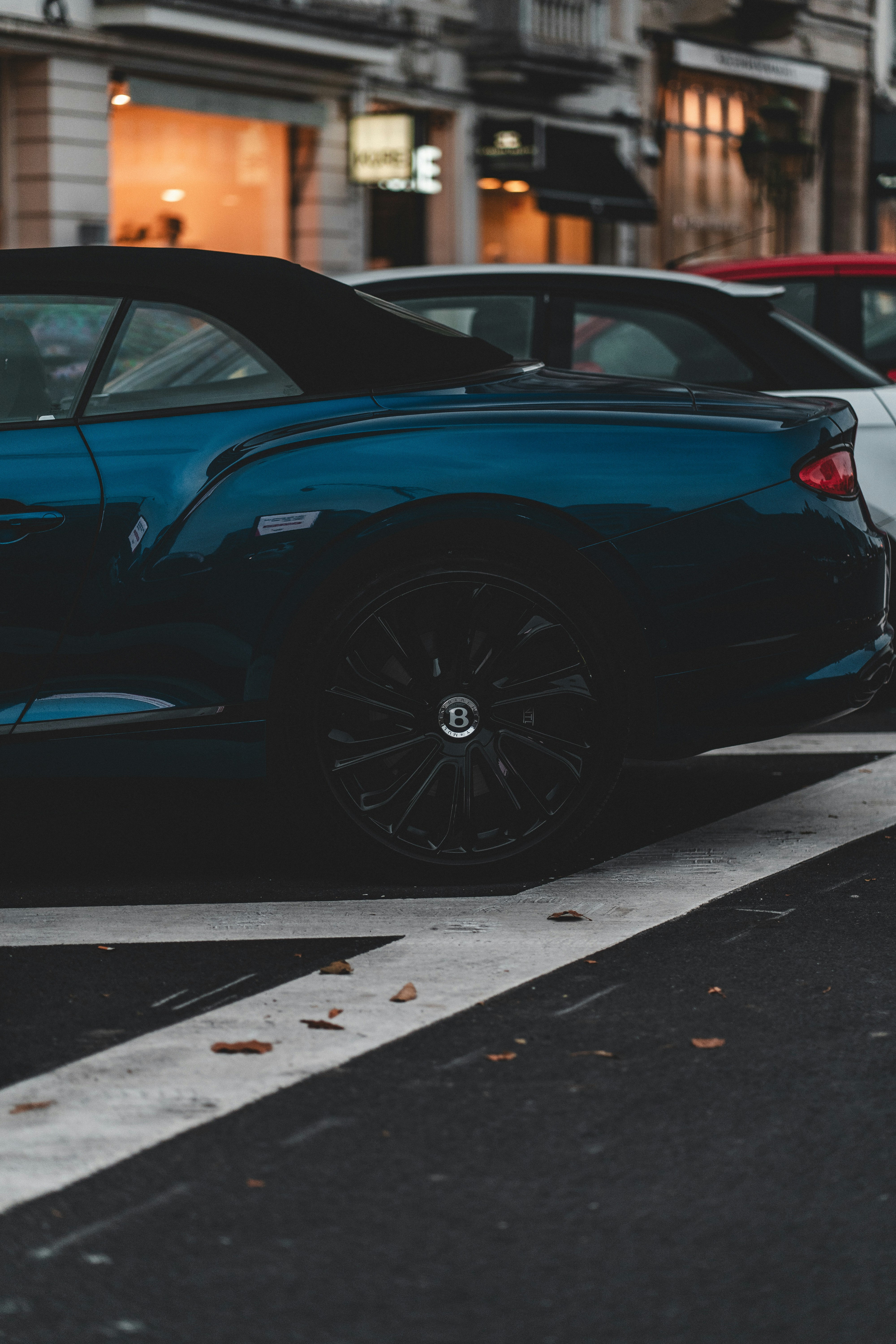 Blue Convertible in Sunset Street: A Quiet Moment Amid City Traffic