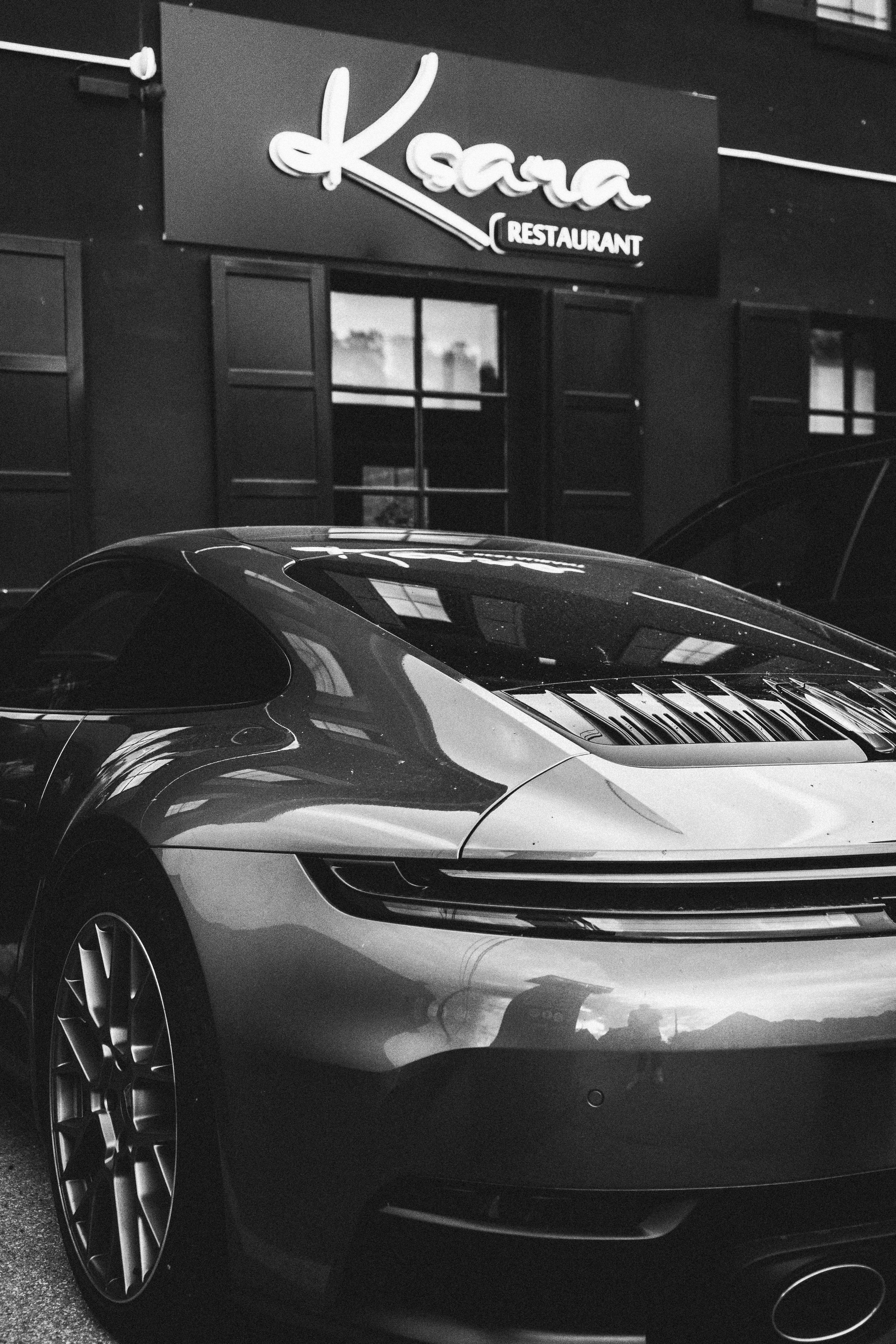 Midnight Arc: A Porsche Cornered by a Neon-Checked Facade