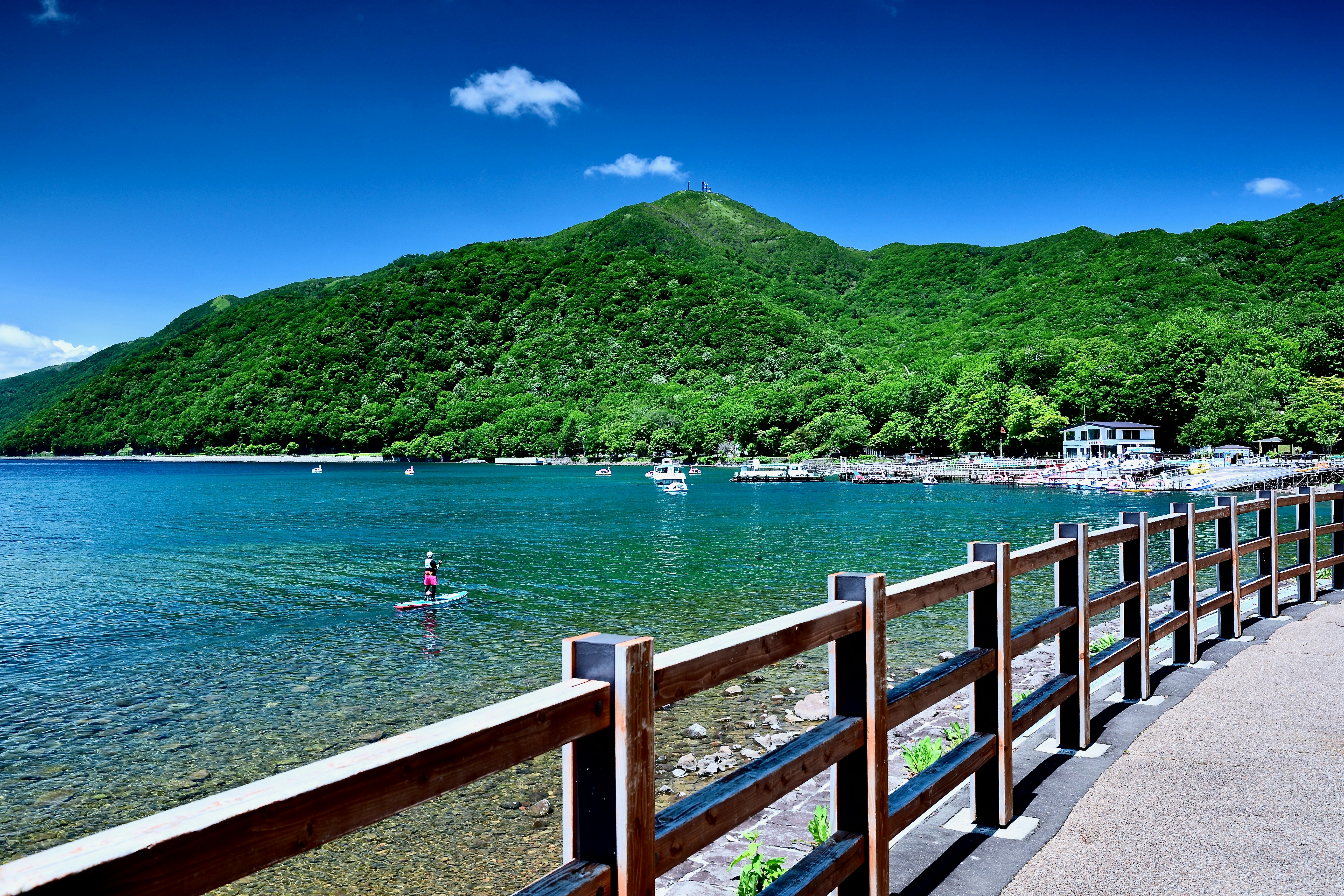 Lakeside Promenade Under a Lush Mountain Sky