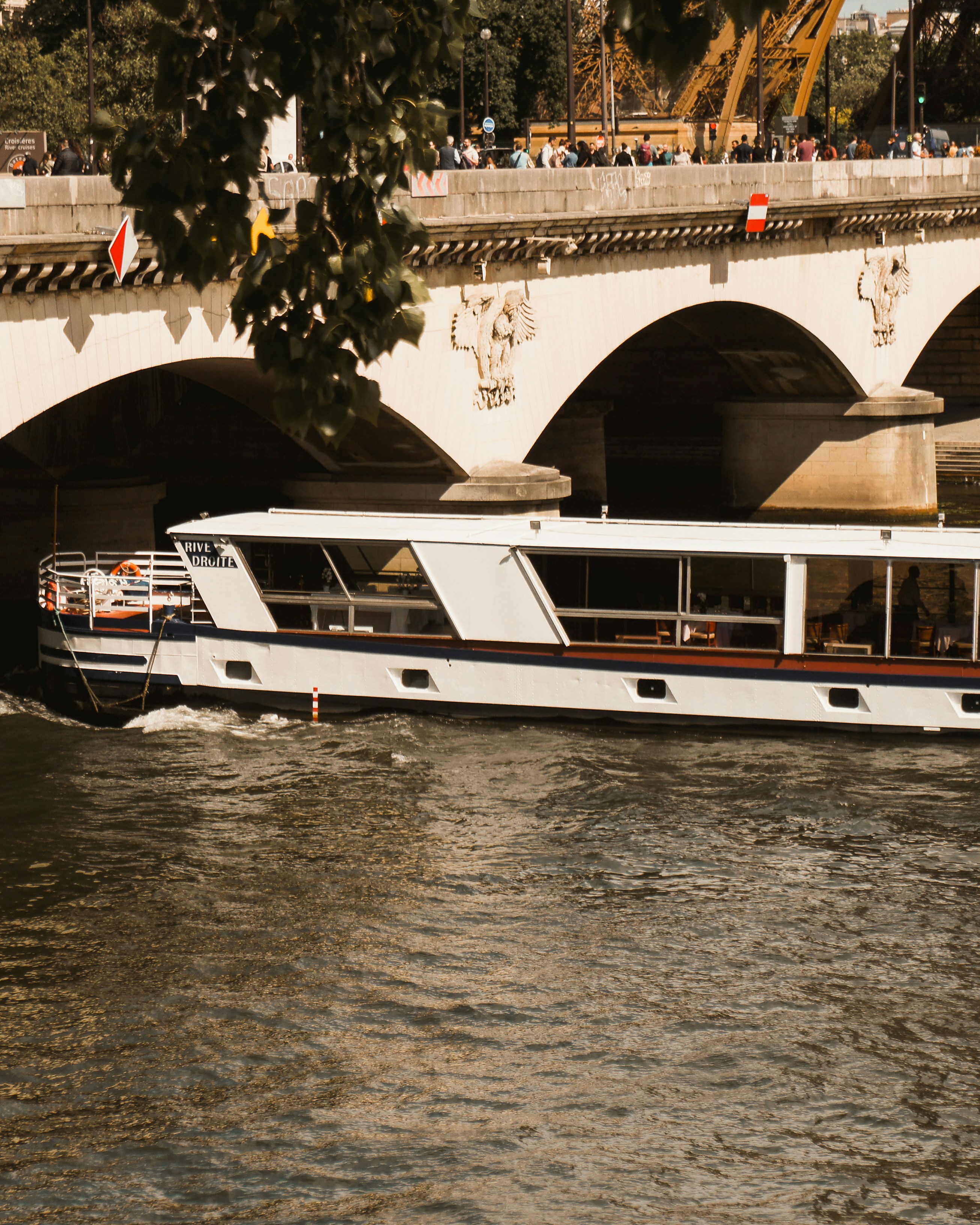 River Vessel Under Stone Arches at Dusk