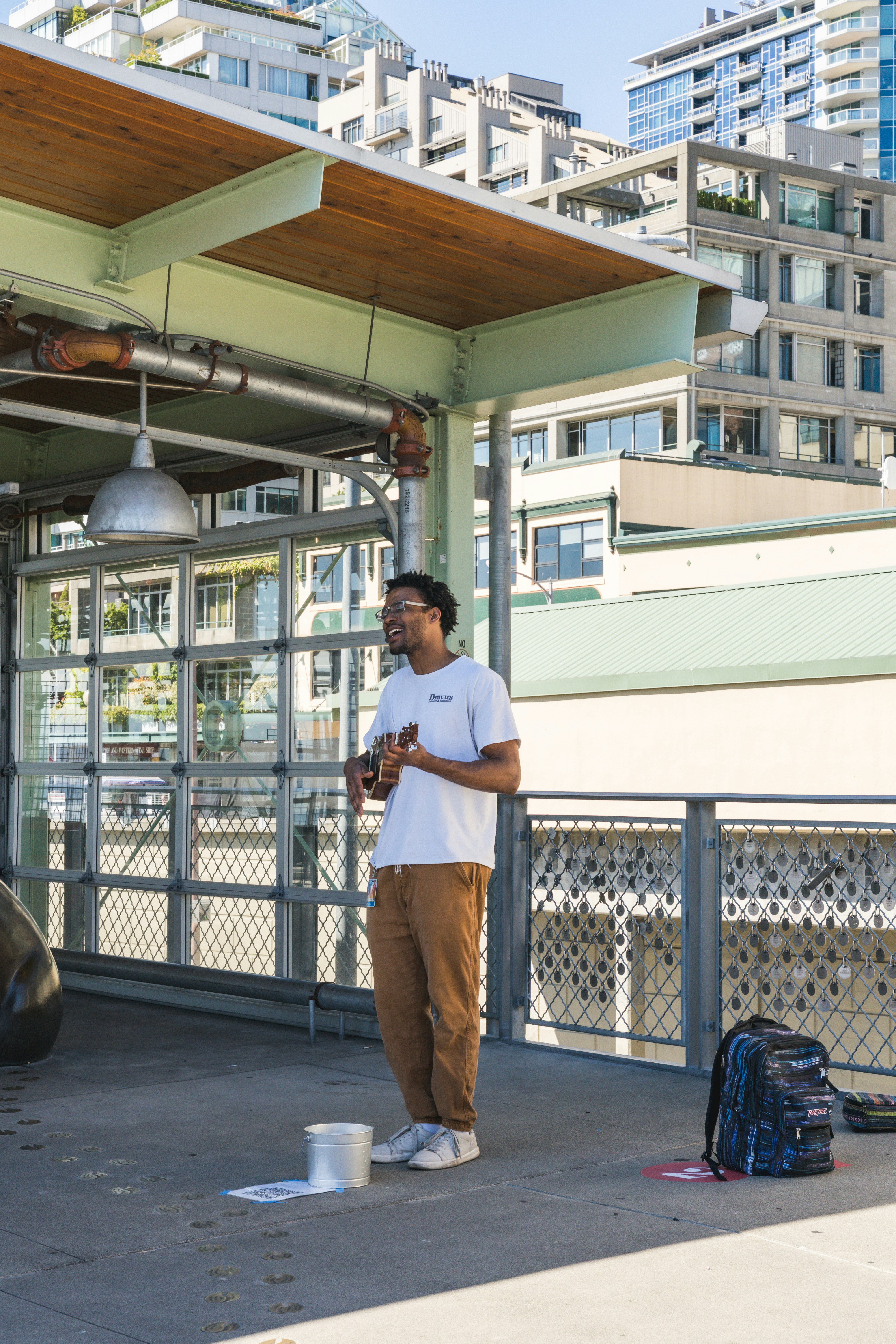 Street musician under an urban canopy
