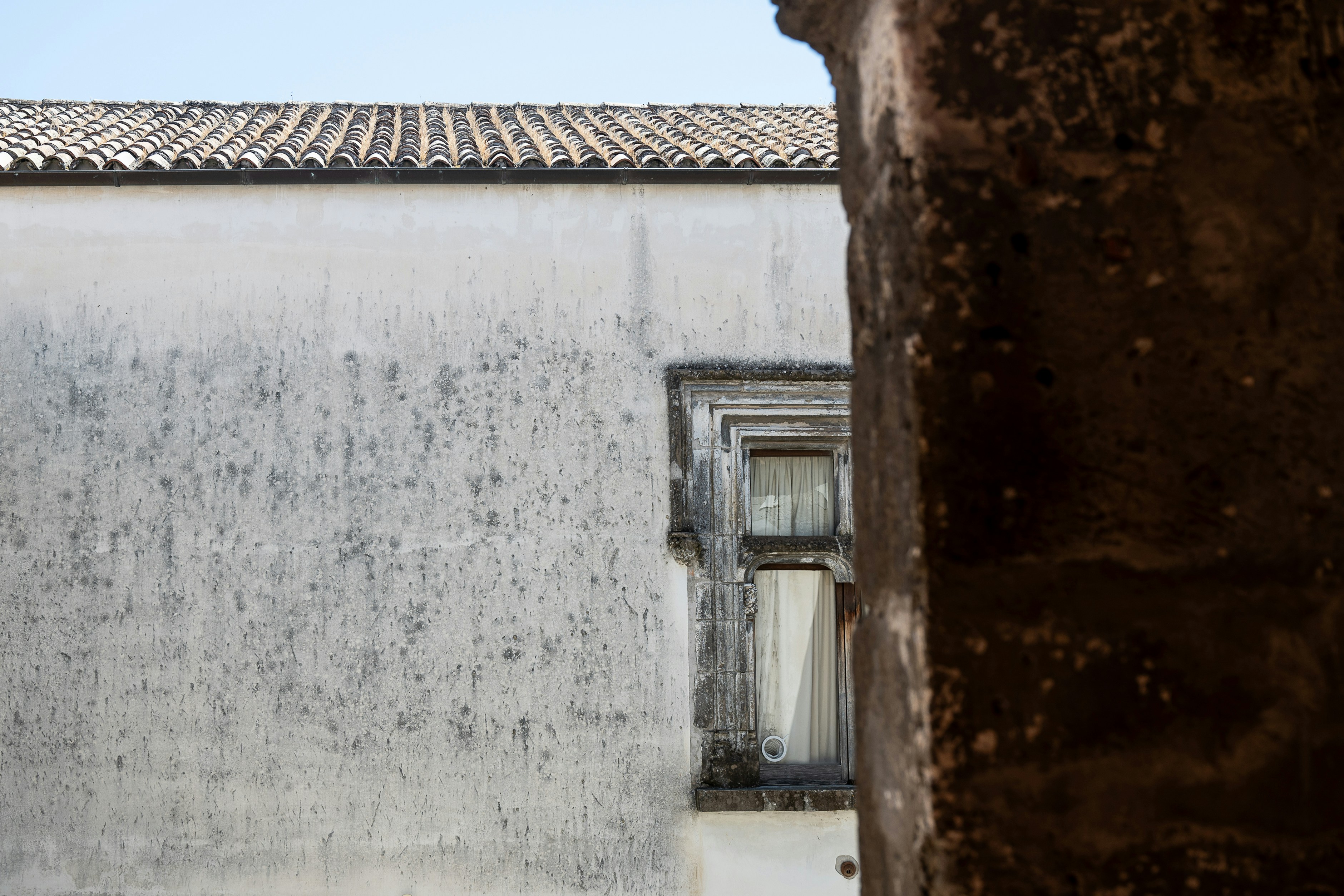 Weathered Facade and Hidden Window