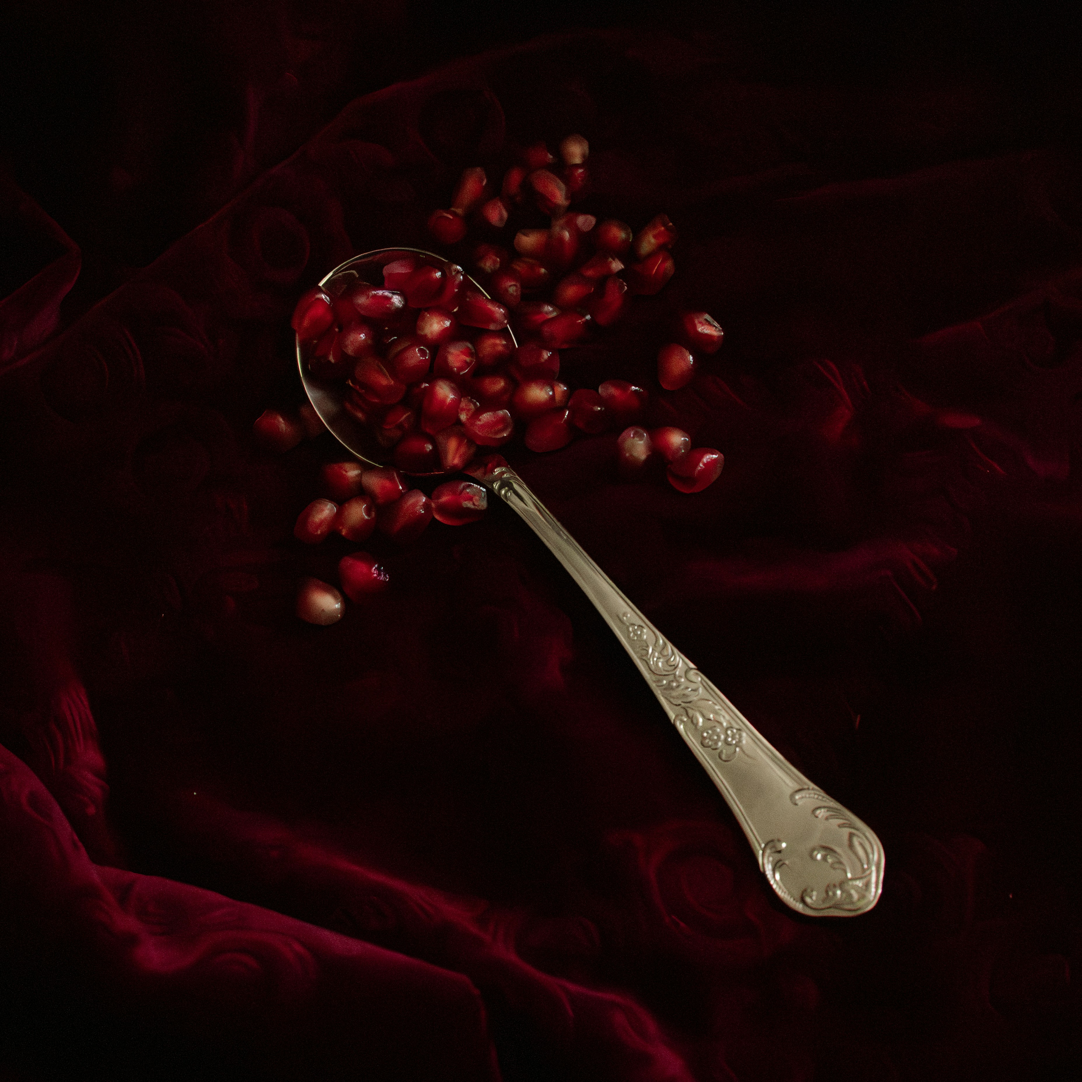 A Silver Spoon Drifts Over Pomegranate Rubies