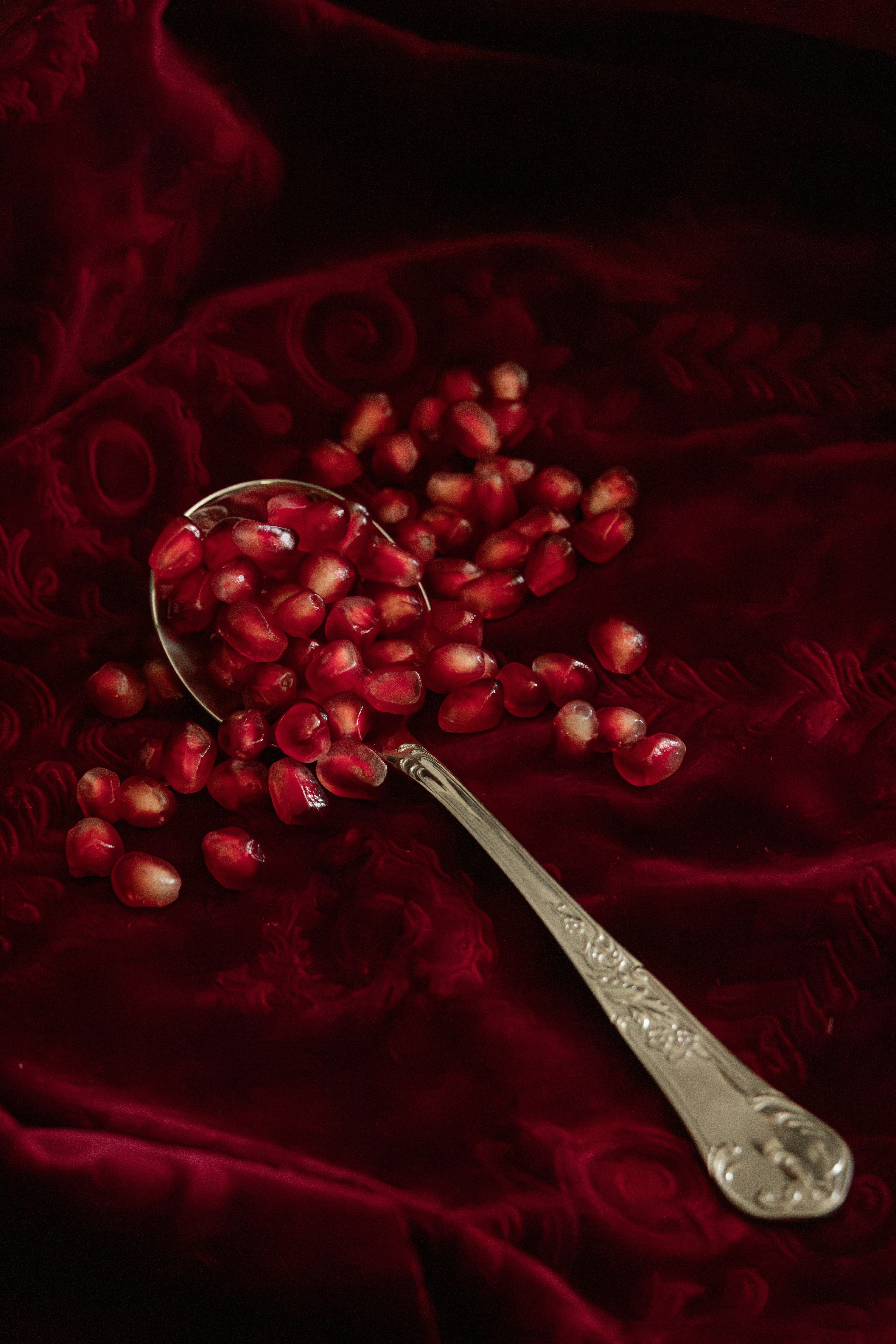 Ruby Confetti in a Silver Dizzy: A Still Life with a Glass Scoop