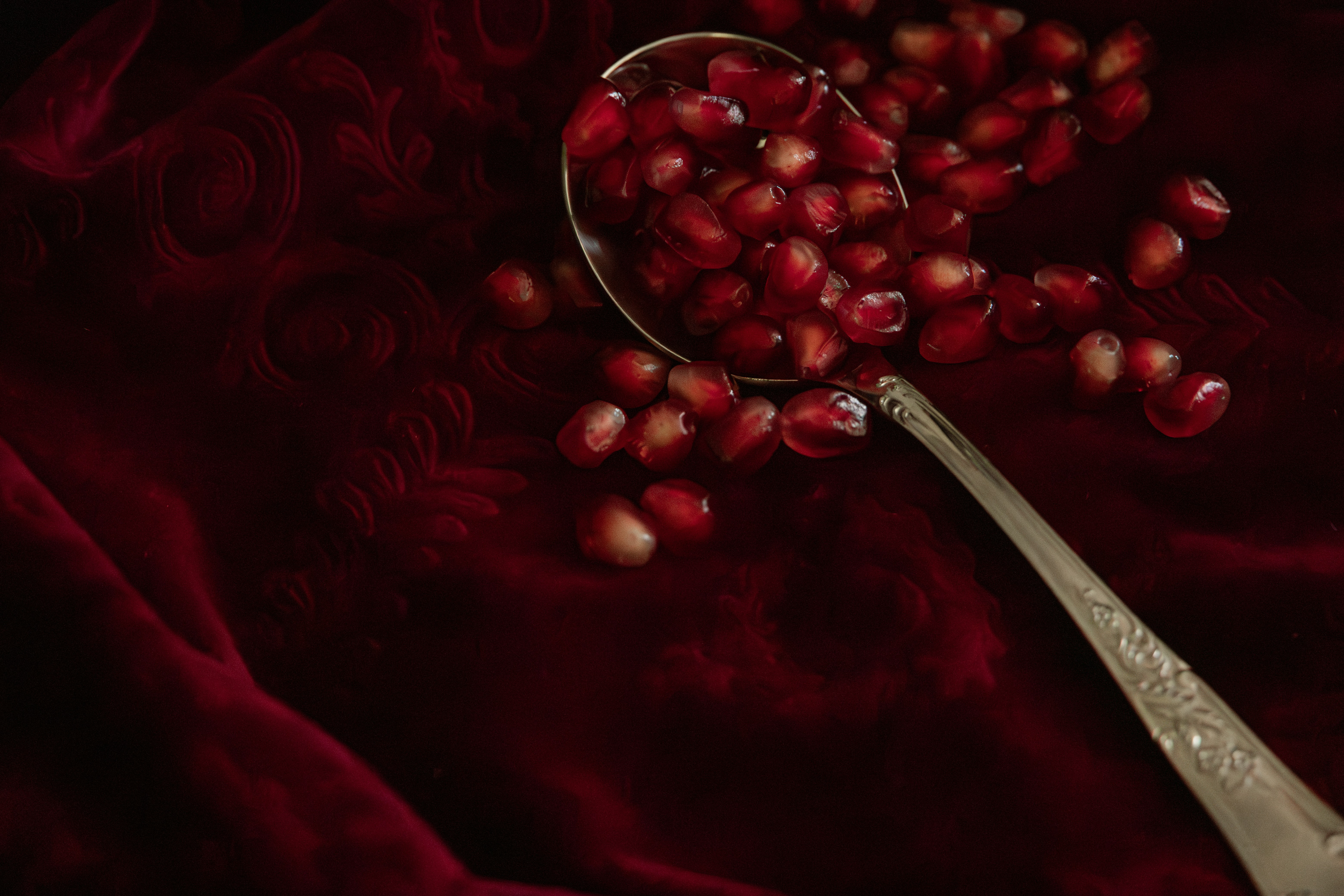 Crimson Halo: A Silver Spoon Spills Ruby Fragments on Velvet Night