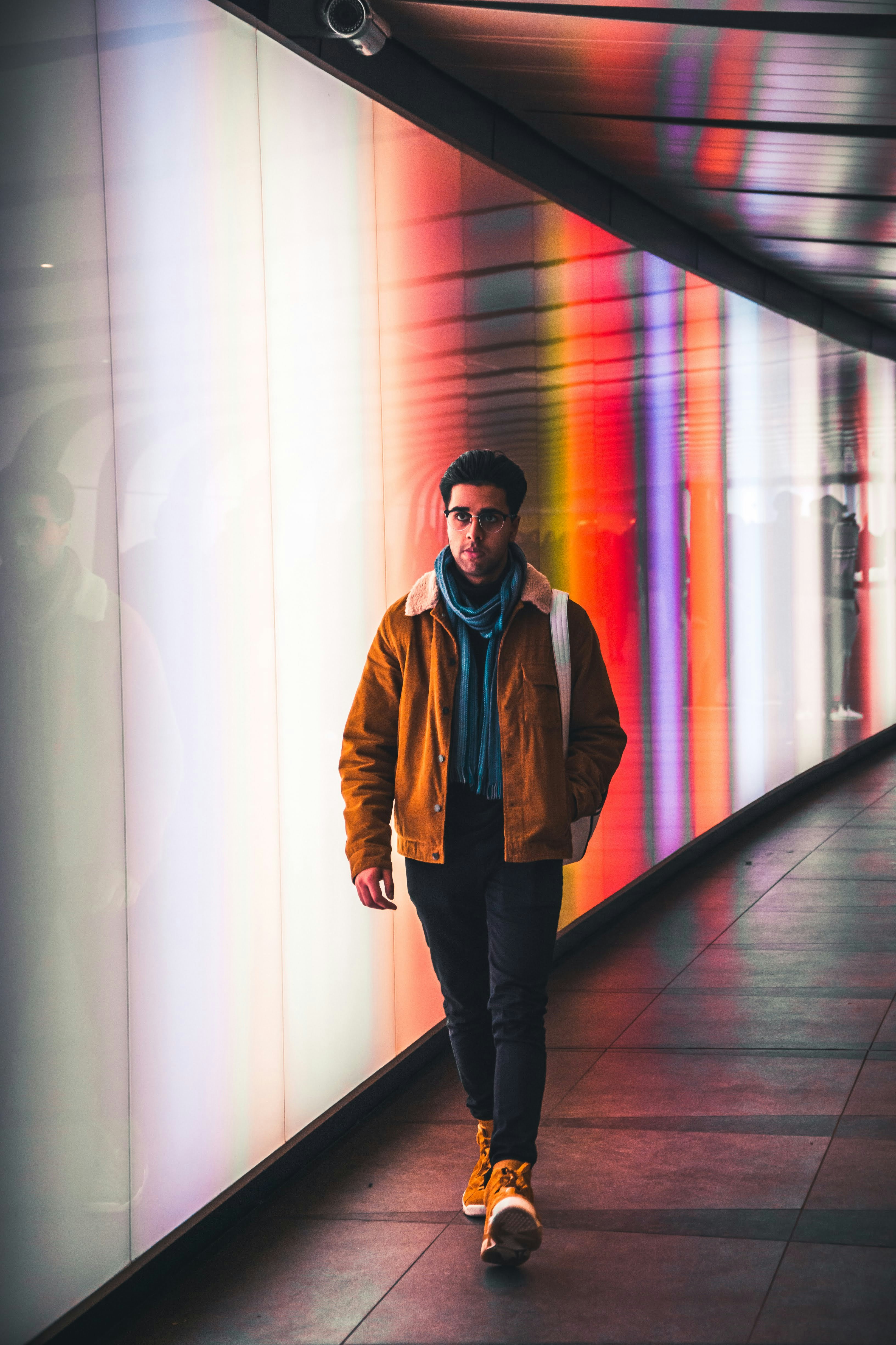 Navigator in Neon Corridor: A Walker Beneath Prismed Light