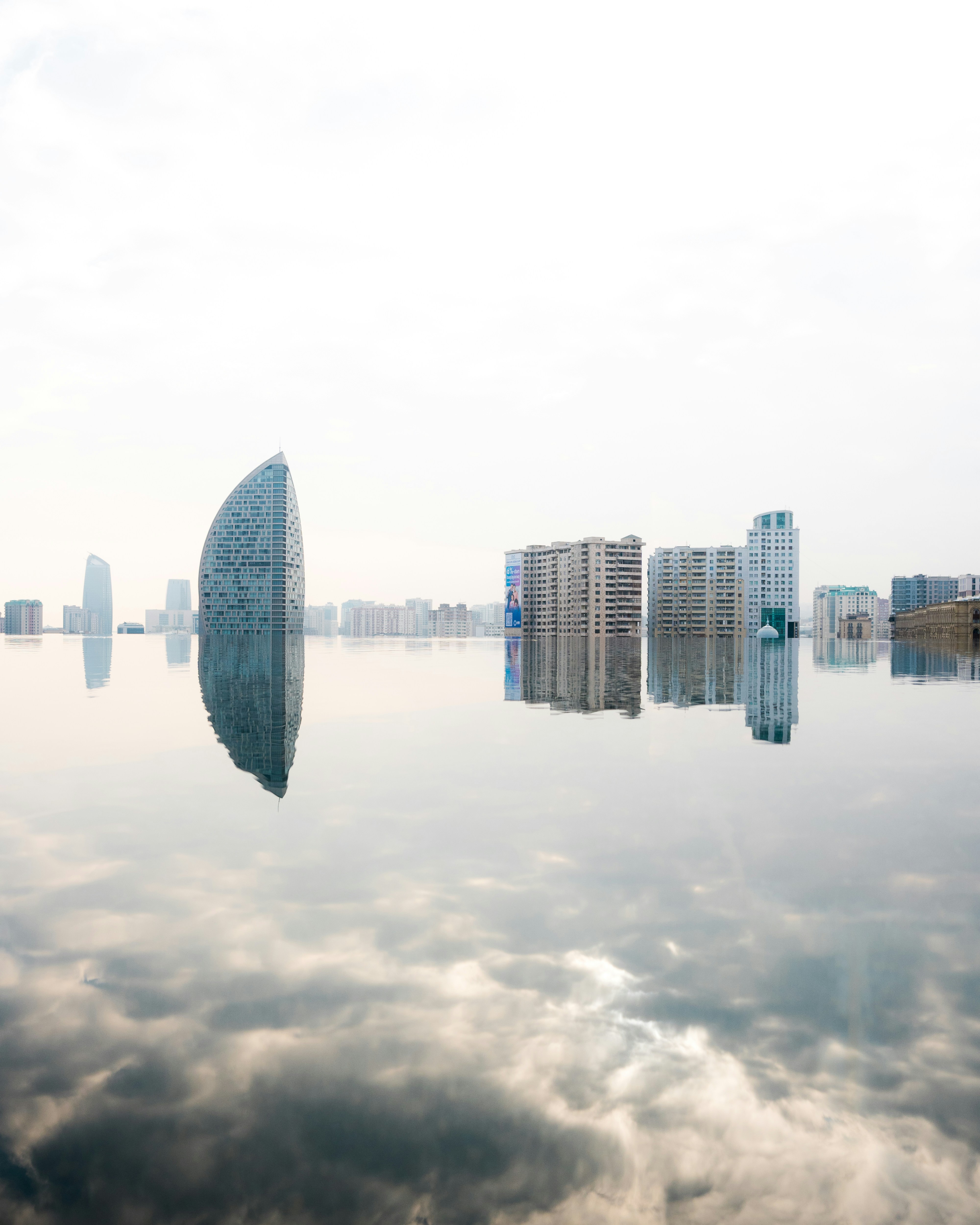 Urban Mirror: Circular Sail Meets Skyscraper Horizon