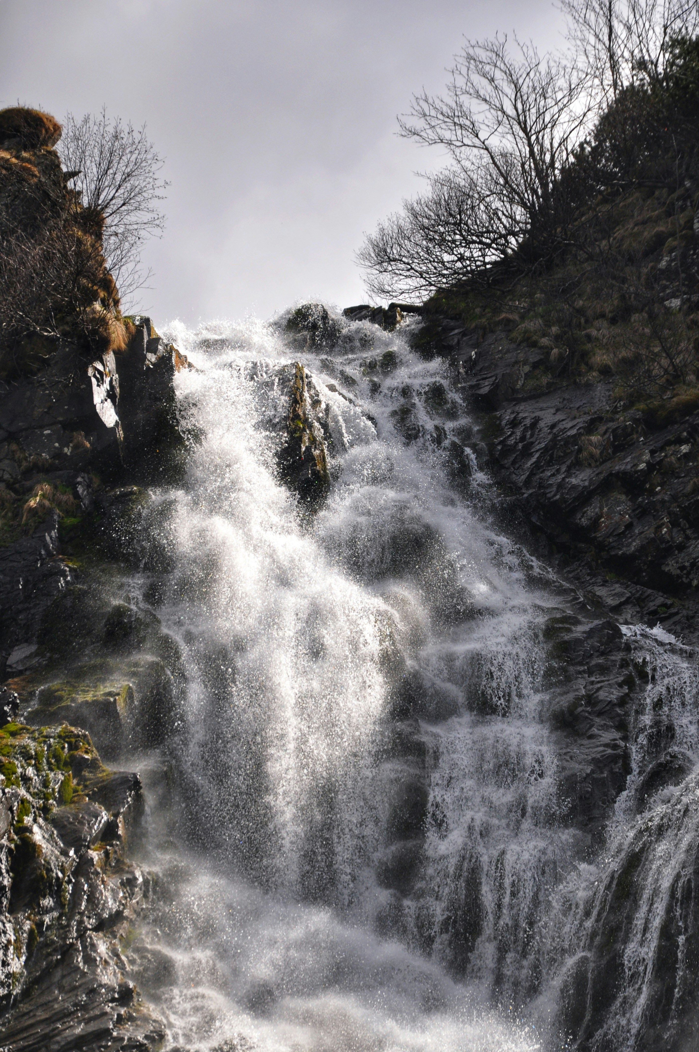 Cascading Veil: A Narrow Waterfall Between Cliff Walls
