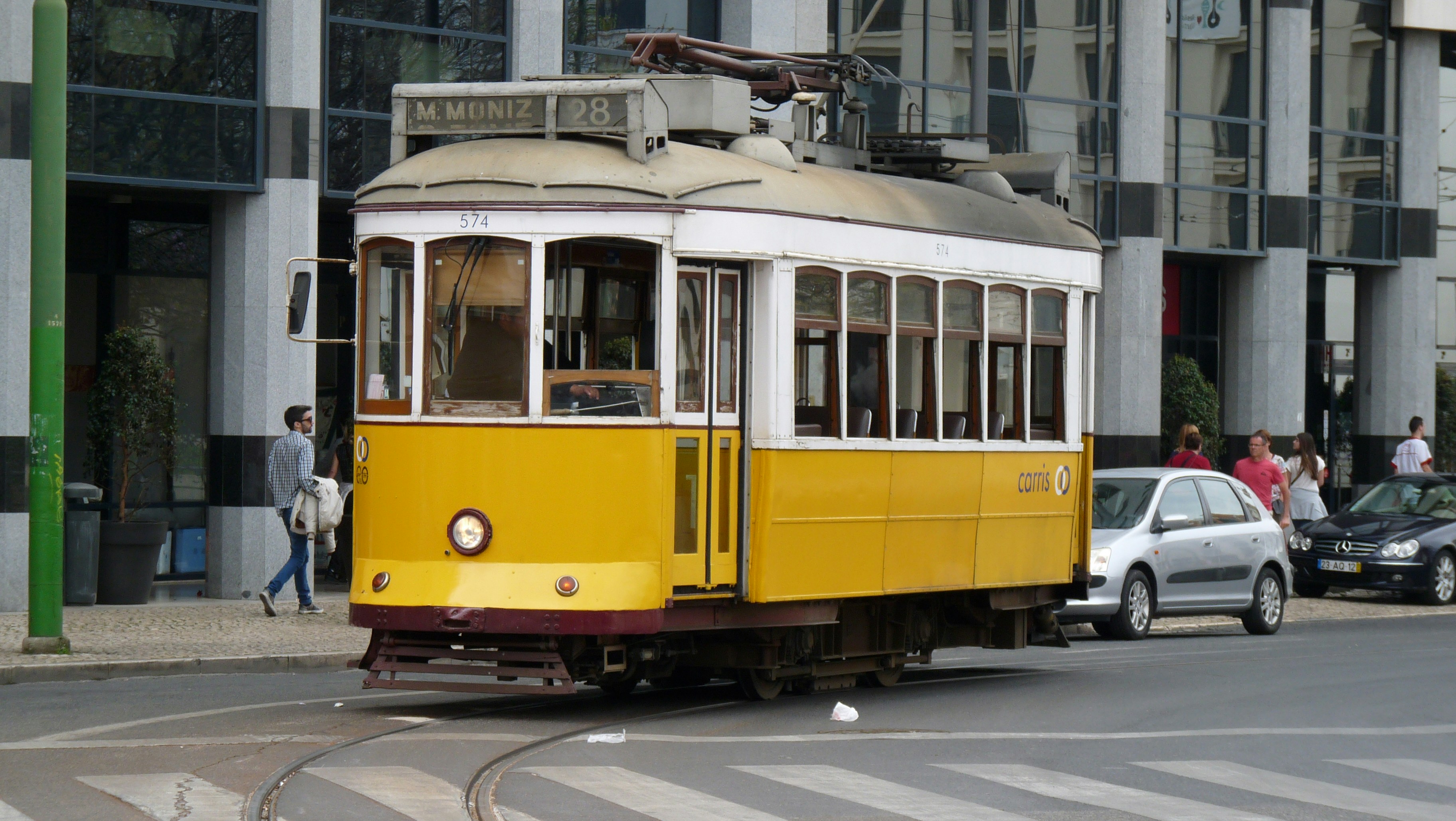 Yellow Tram Crossing: Streetcar Amid Modern Architecture