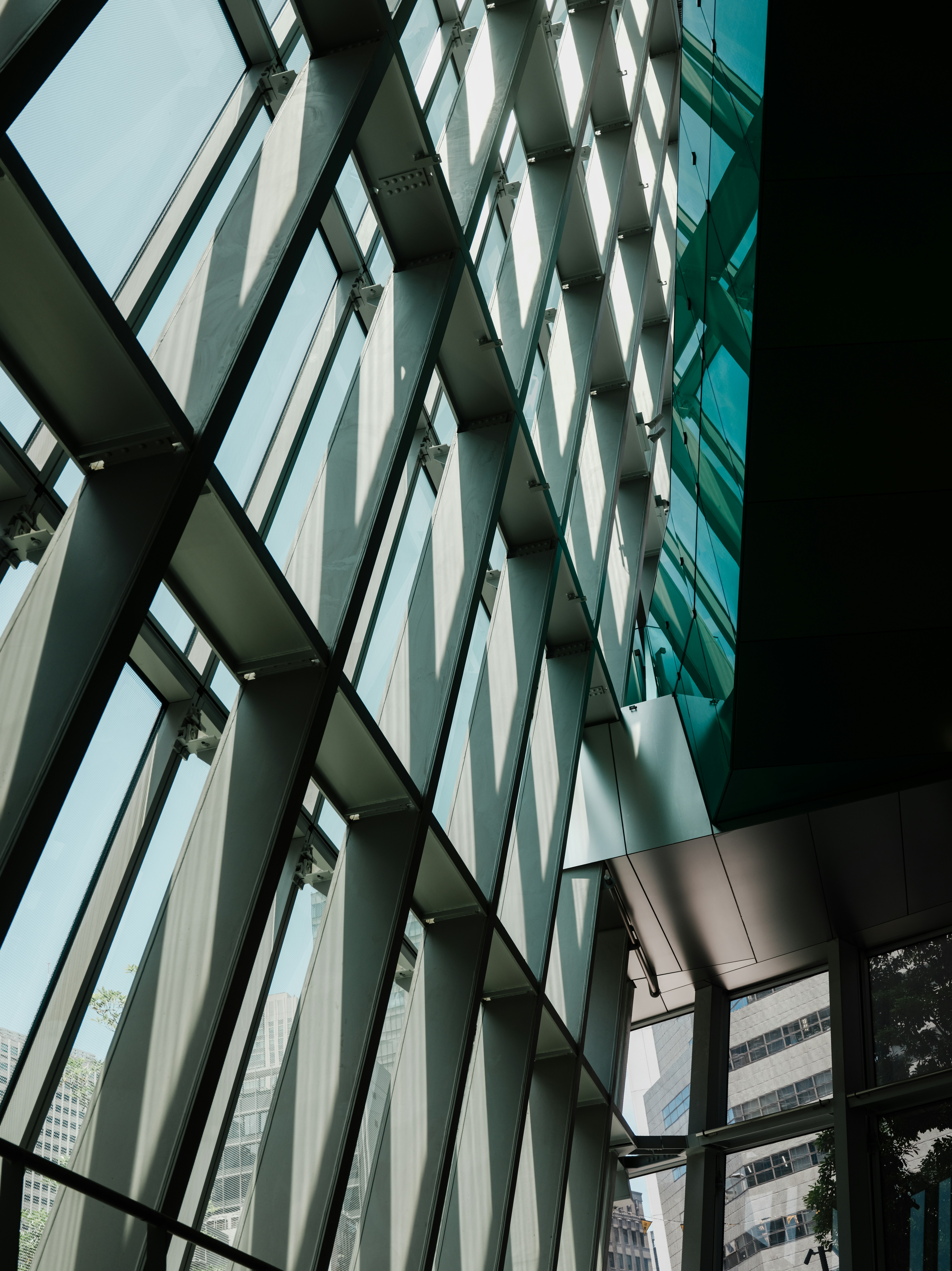Geometric Glass Facade: Angled Light and Shadow in Modern Architecture