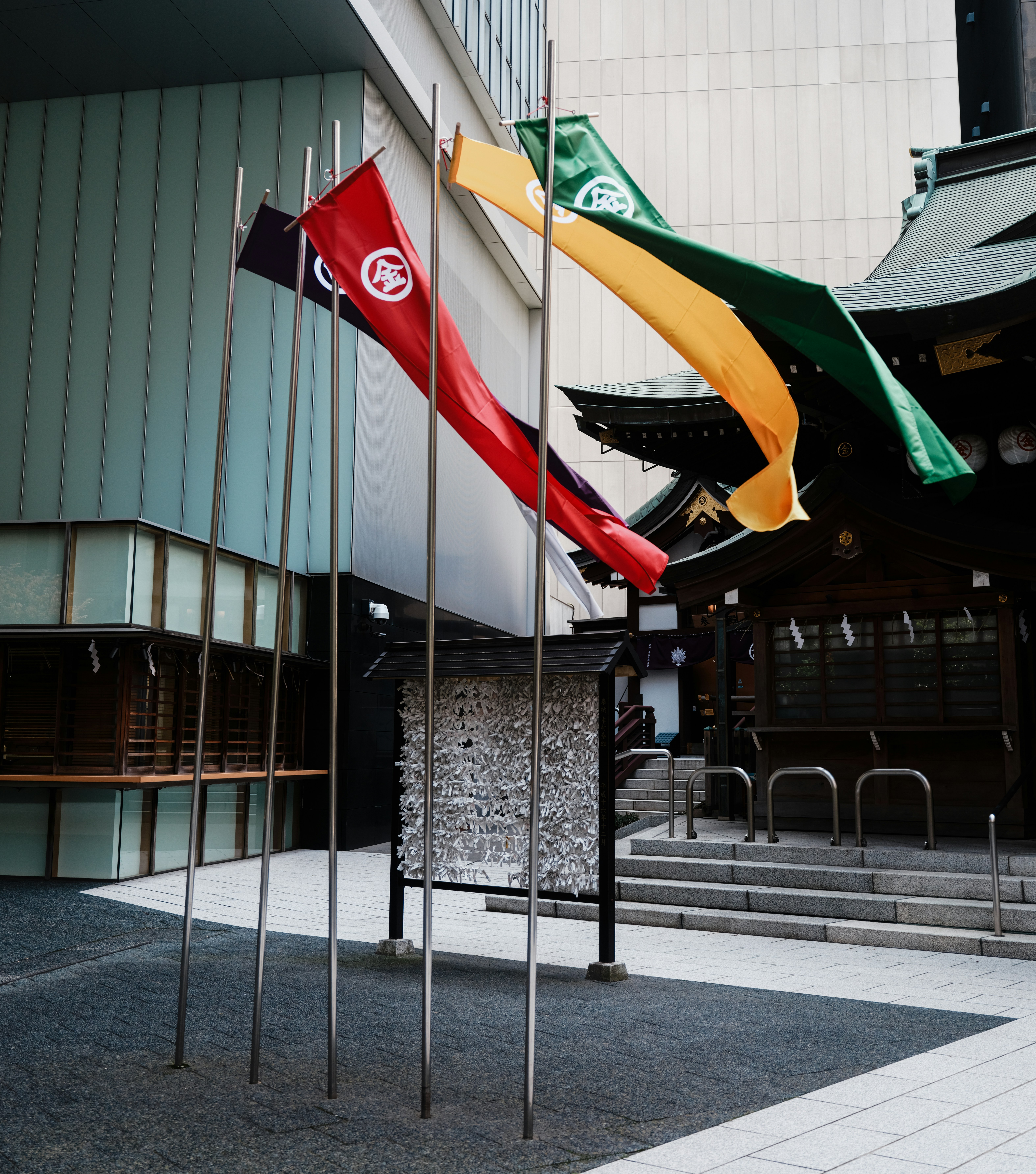 Flags in front of a modern and traditional building