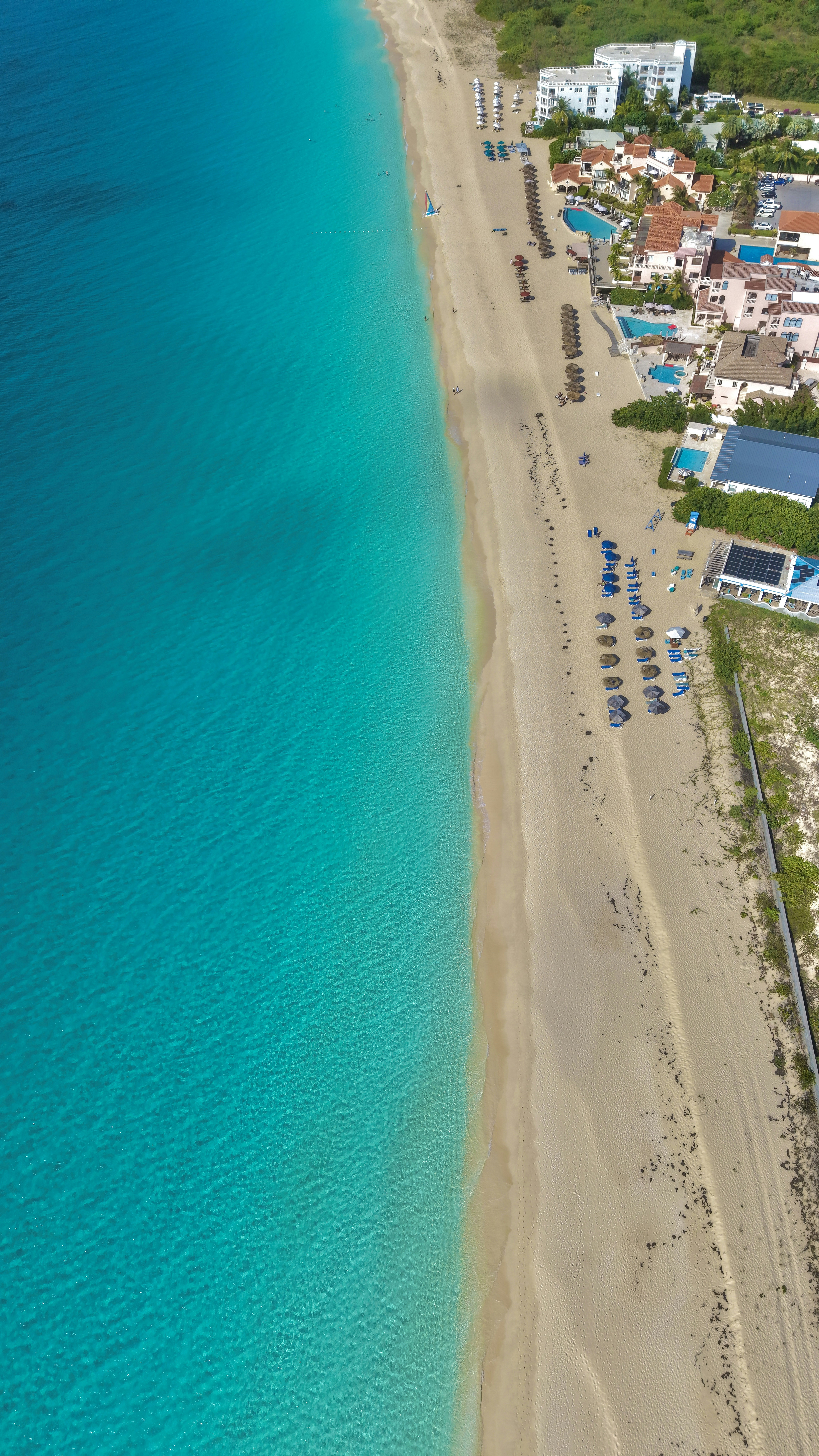 Aerial Slice of Turquoise Coast: Beachfront Village and Clear Waters