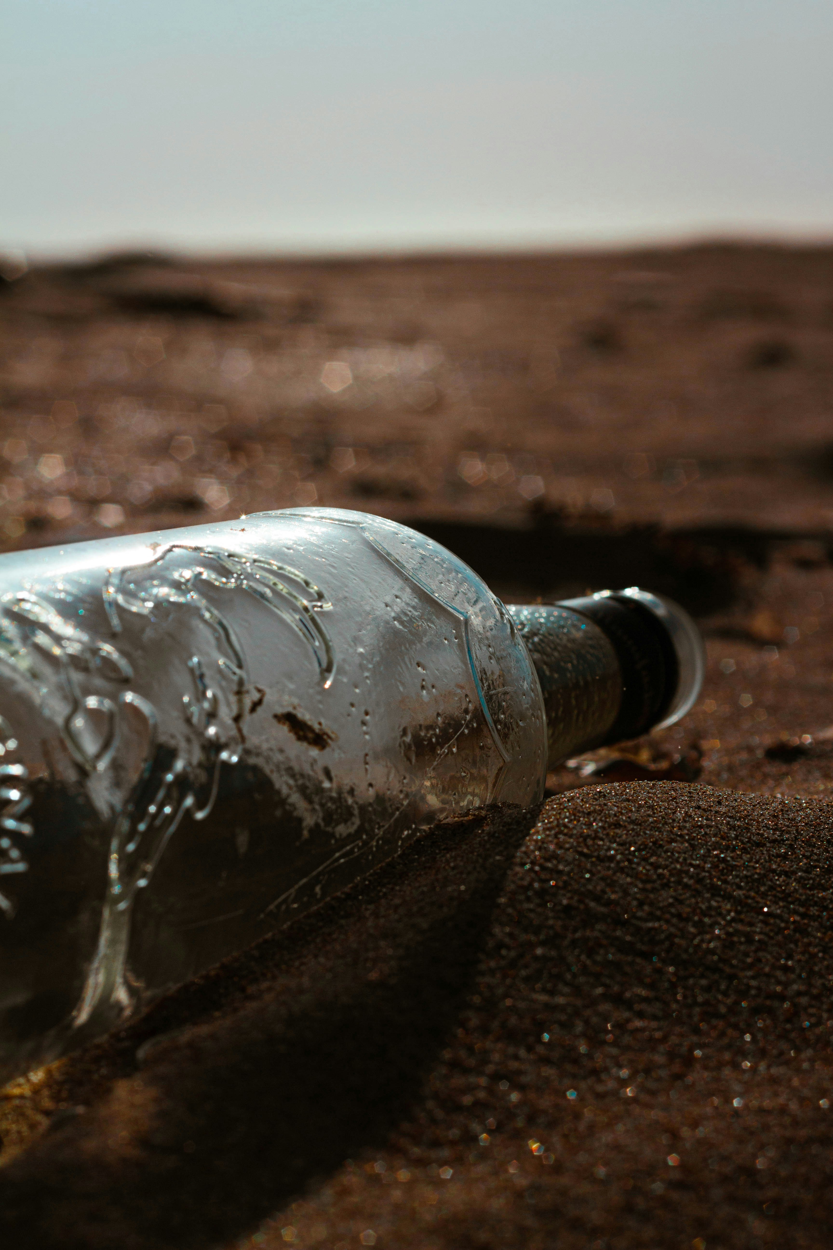 Desert Bottle Adrift on a Matte Sea