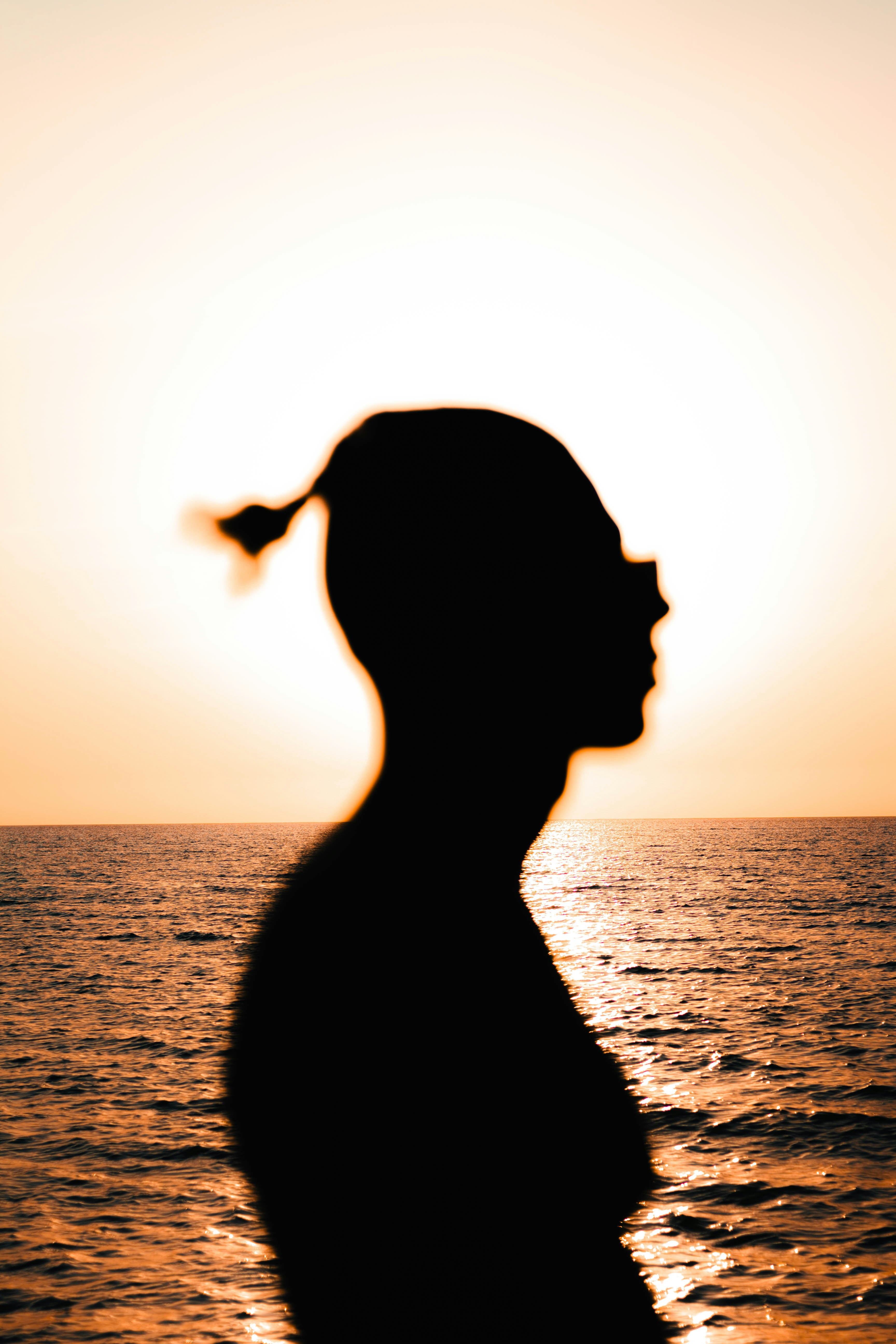 Silhouette at Sunset: Profile Against a Calm Sea