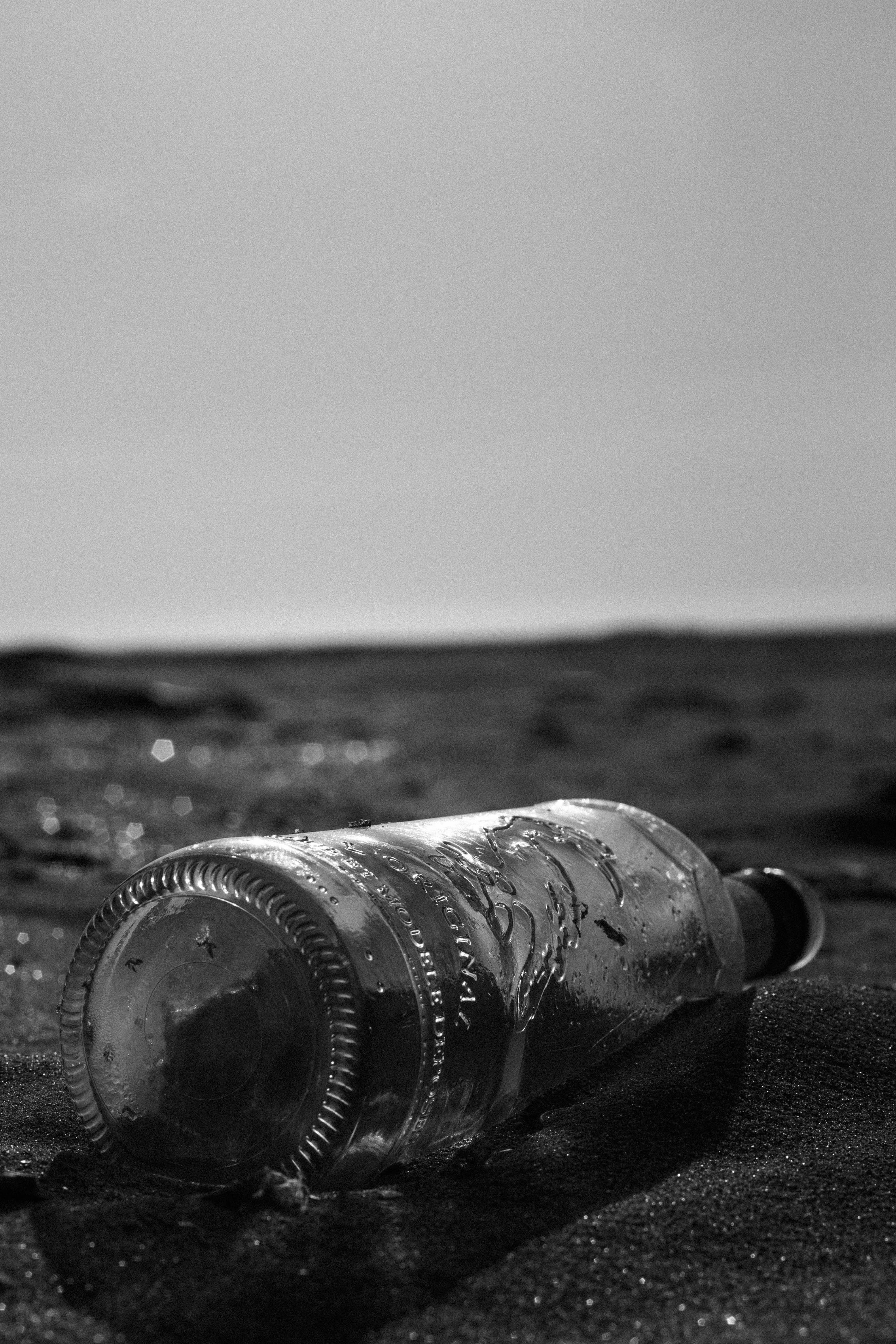Drifted Moment: A Crumpled Glass on the Desert Sand