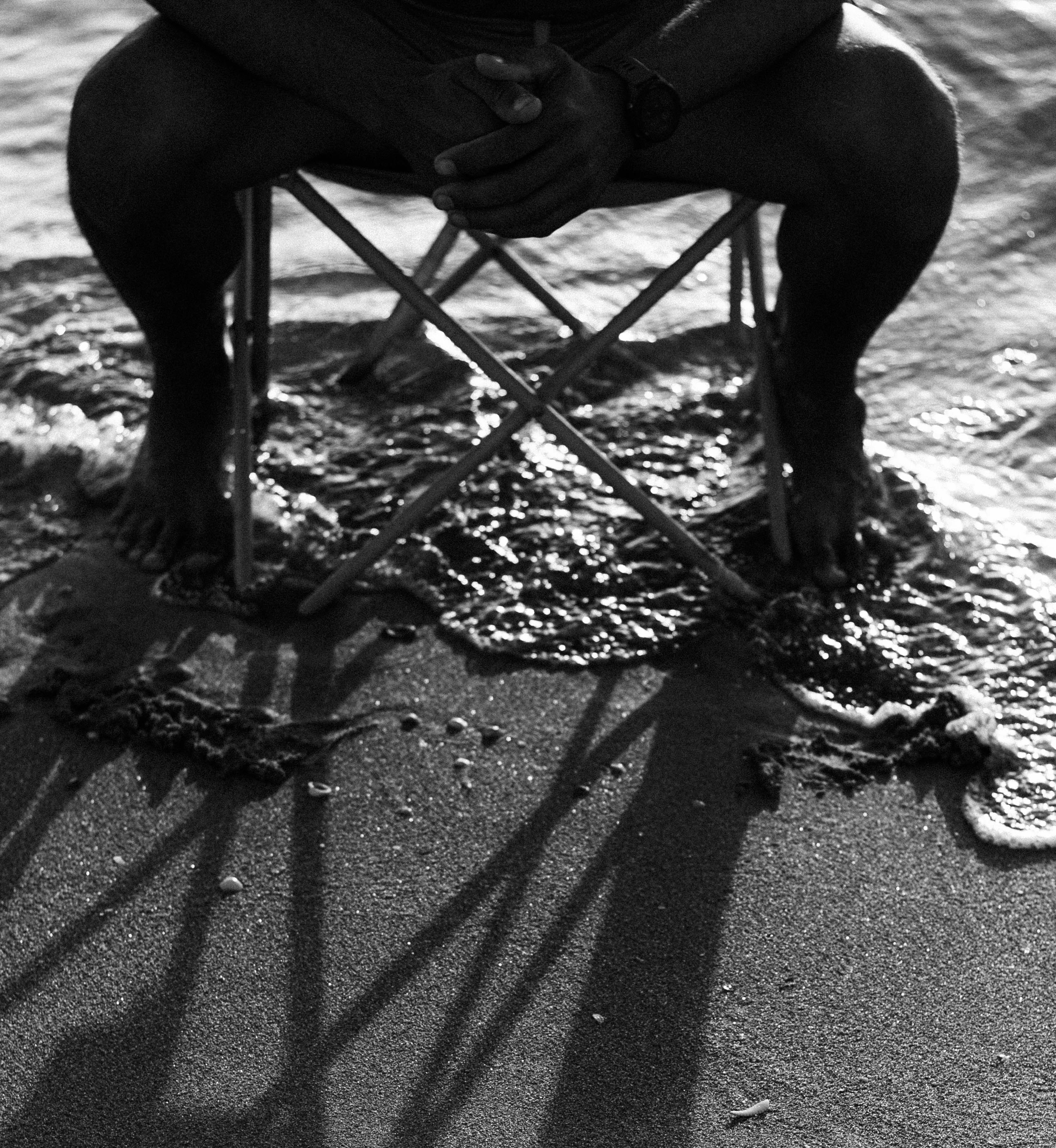 Shaded Foreground, Quiet Edge: A Seated Silhouette at Shoreline