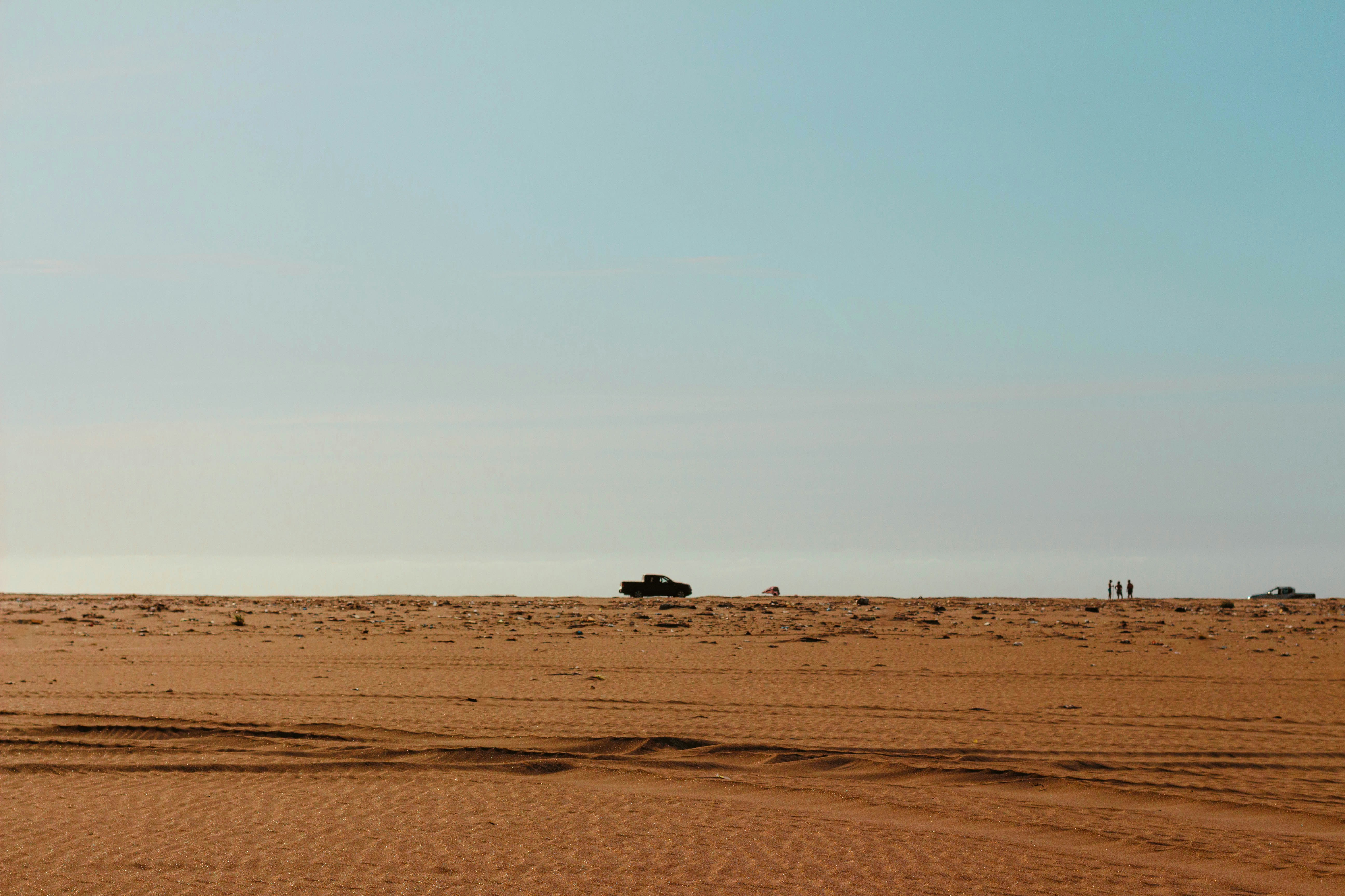 Desert Horizon: A Quiet Line of Vehicles at Dusk