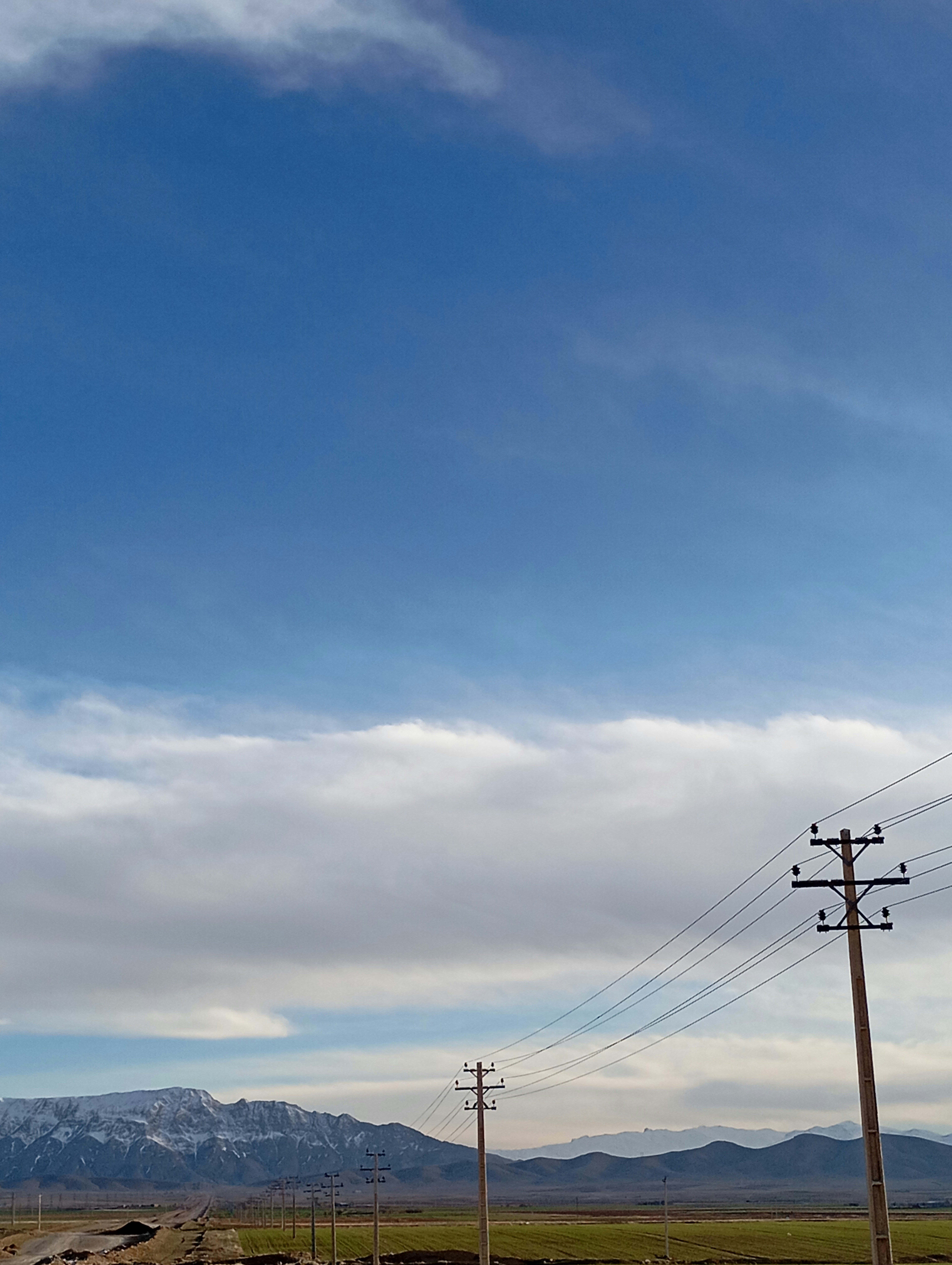 Rails to the Sky: A Quiet Dryland Horizon under a Wide Blue