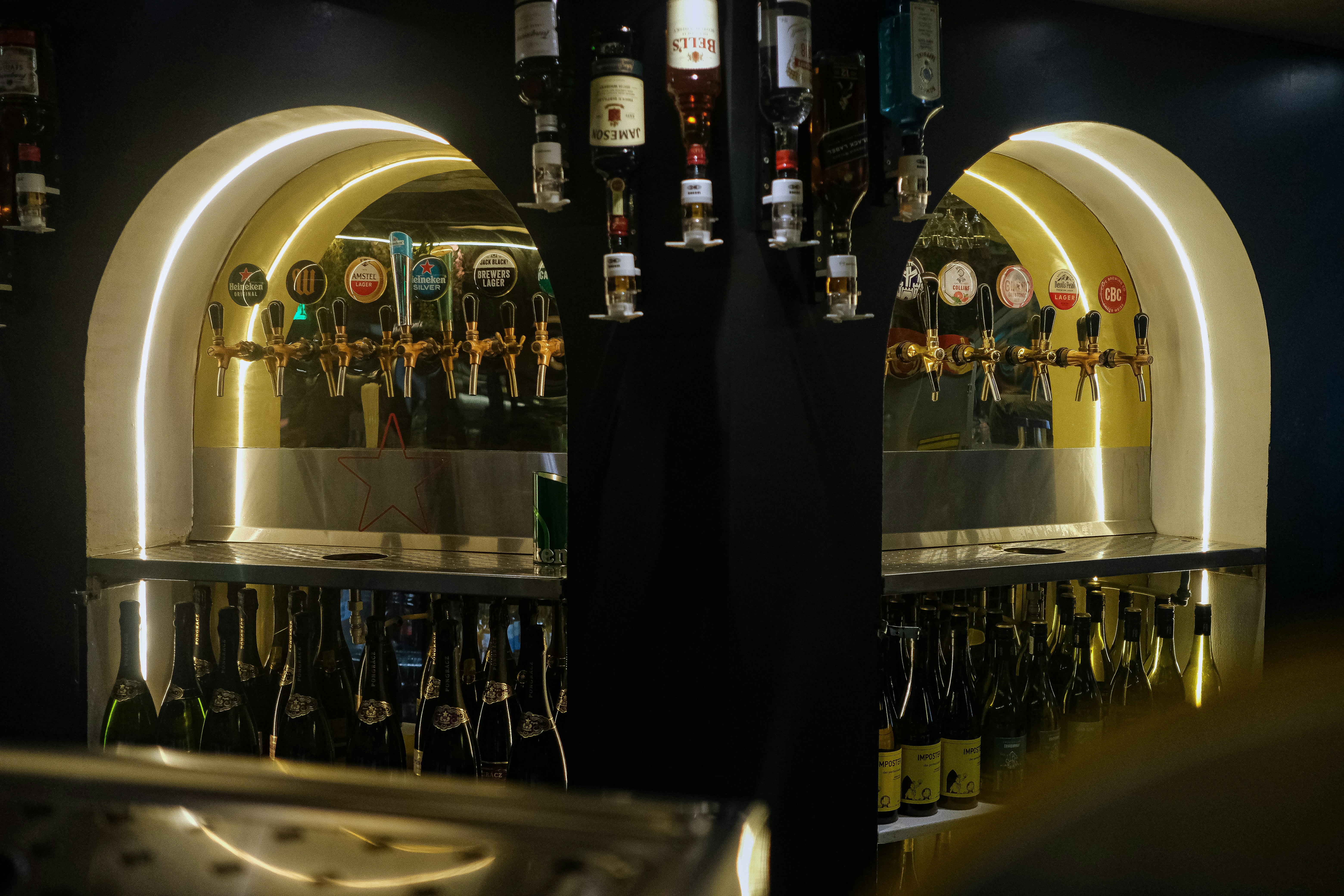 Twin Neon Arches: Bottles, Lights, and Bar Symmetry
