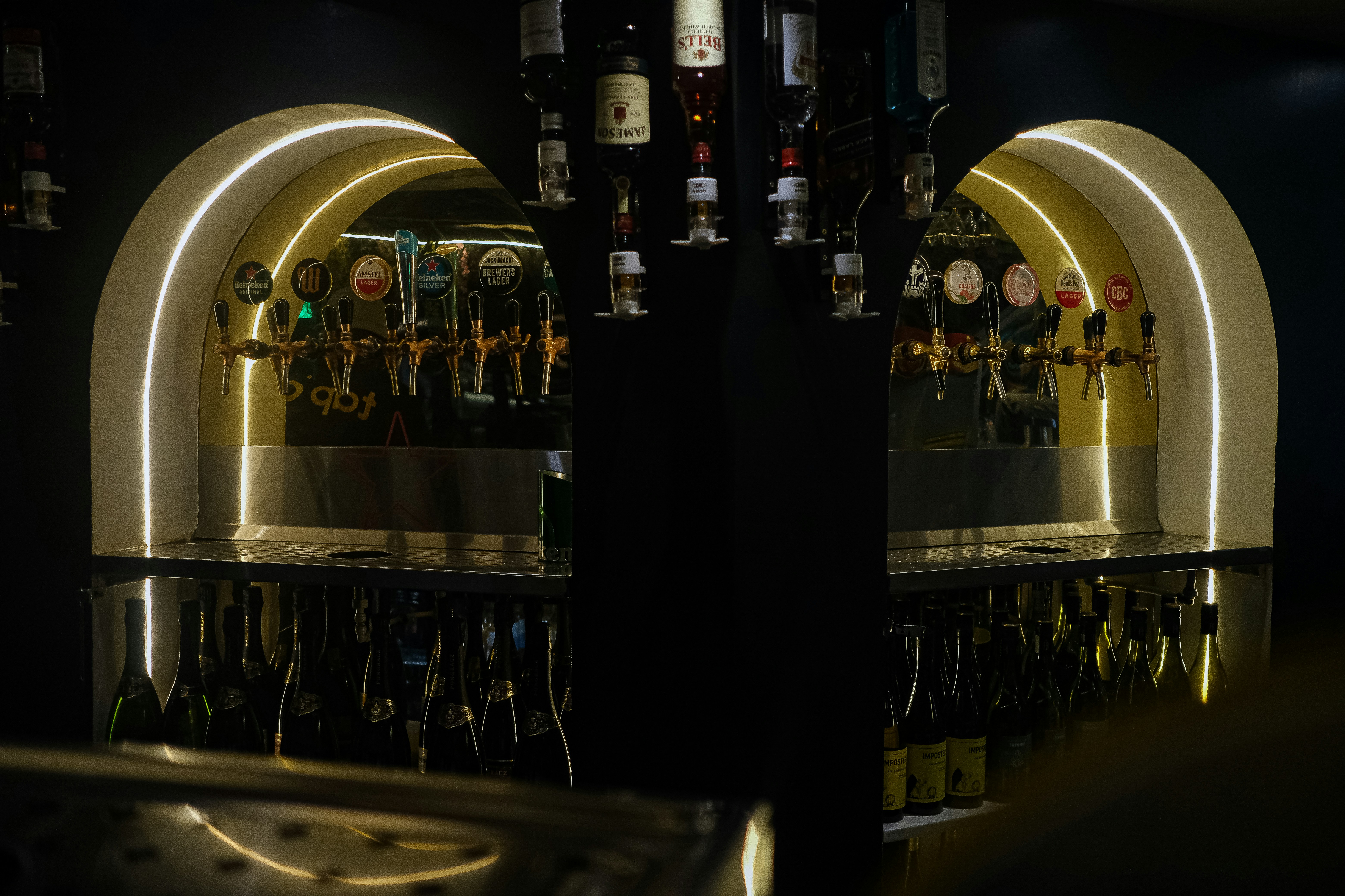 Twin Arches of Night: A Seething Bar Backlit by Neon and Glass