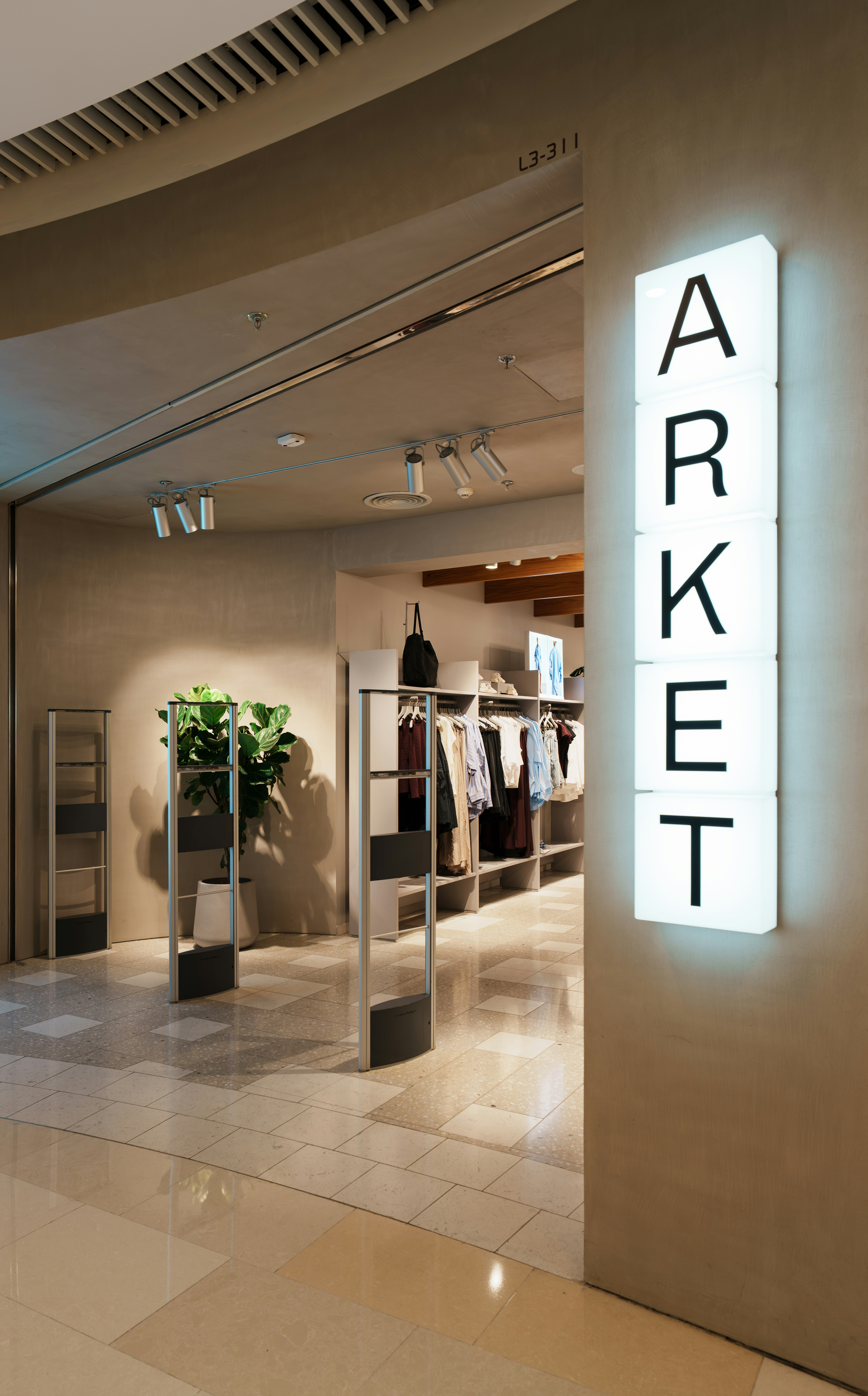 Neon Arket Signlit Path: A Boutique Entrance in Subtle Warmth
