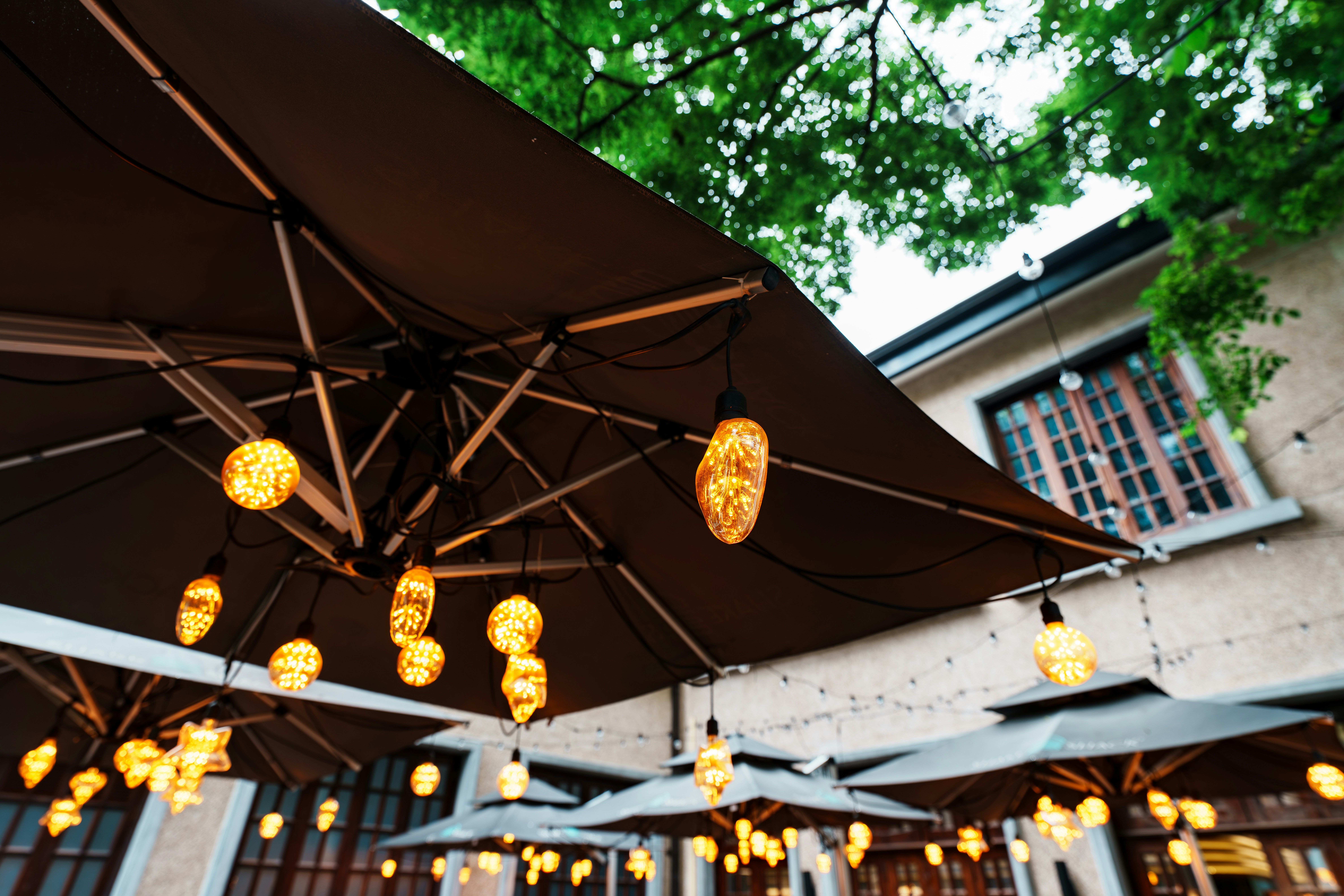 Lanterns in the Courtyard: Warm Glass Orbs above Quiet Tables