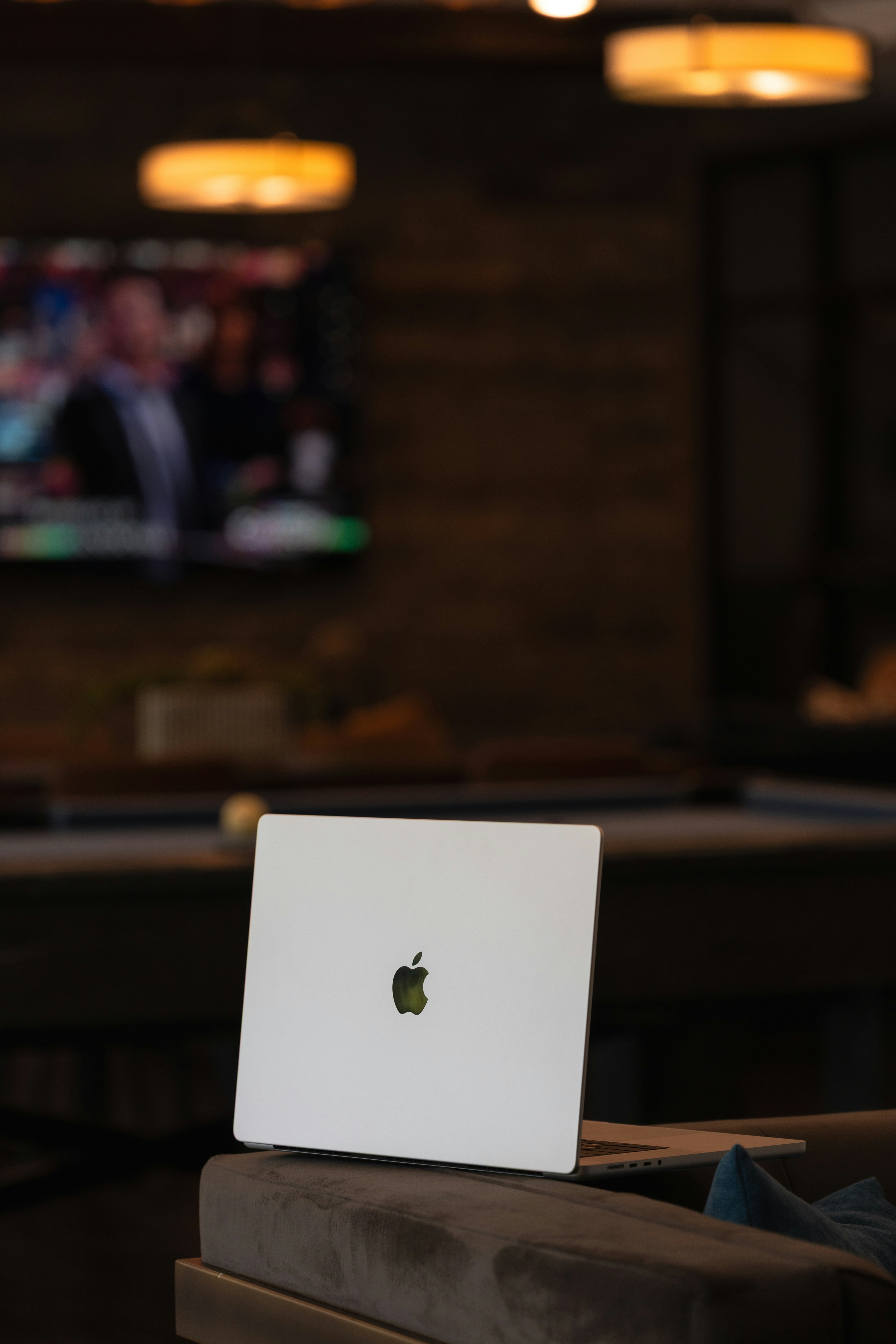 Silent Focus: The MacBook on the Couch in a Quiet Lounge