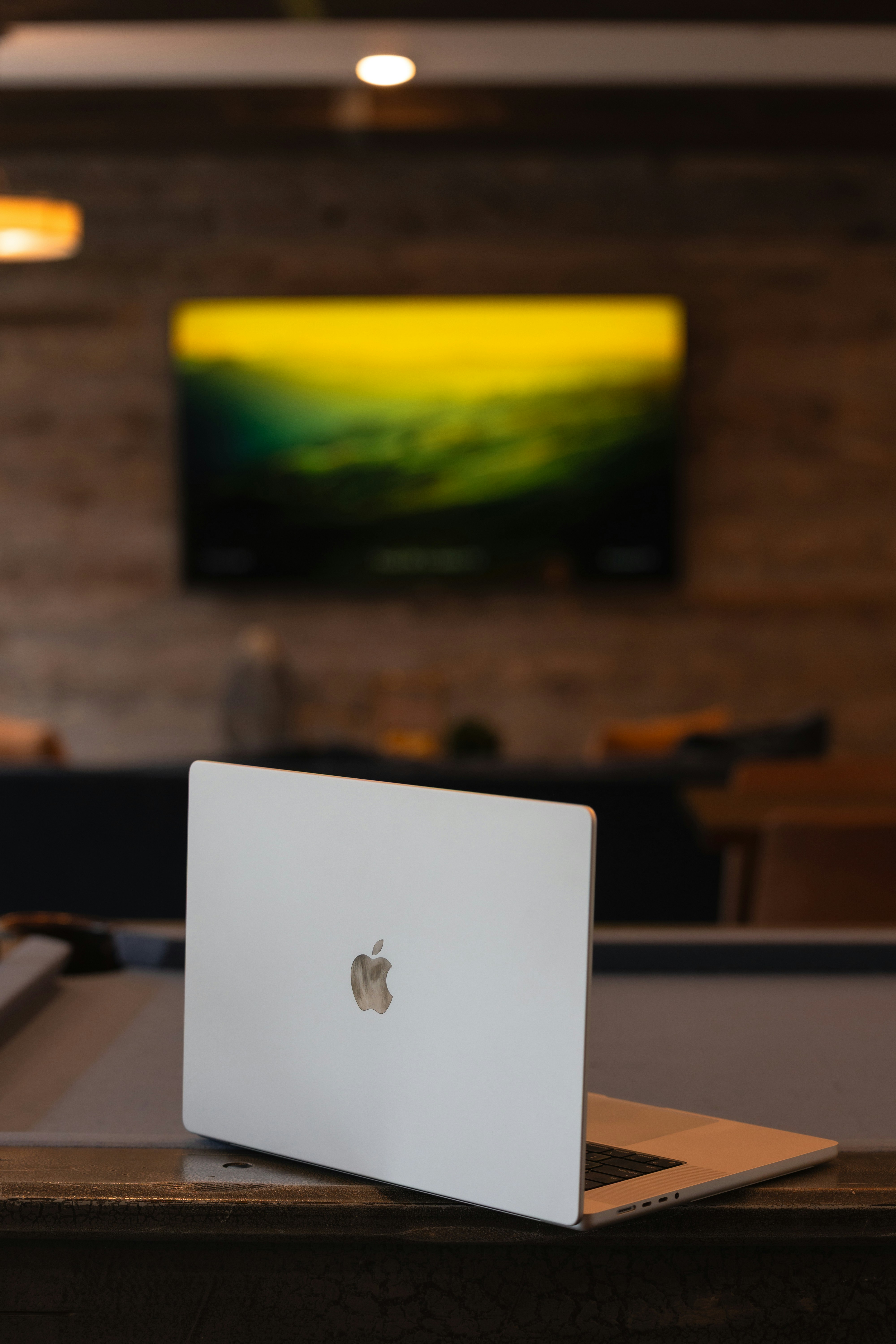 White MacBook on a Bar-Height Counter in a Cozy Studio