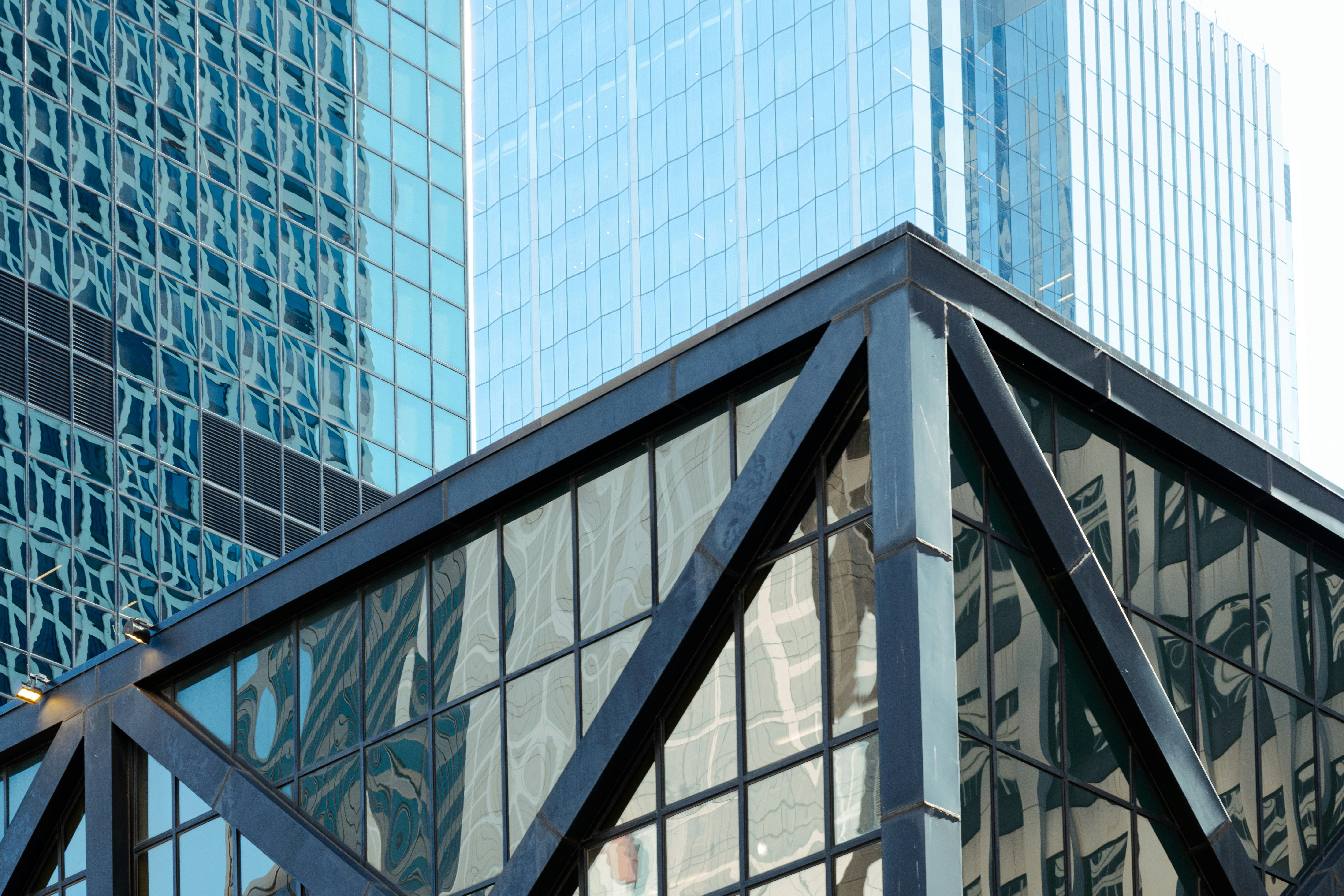Glass Facade Geometry: Intersecting Frameworks Reflect a Cityscape