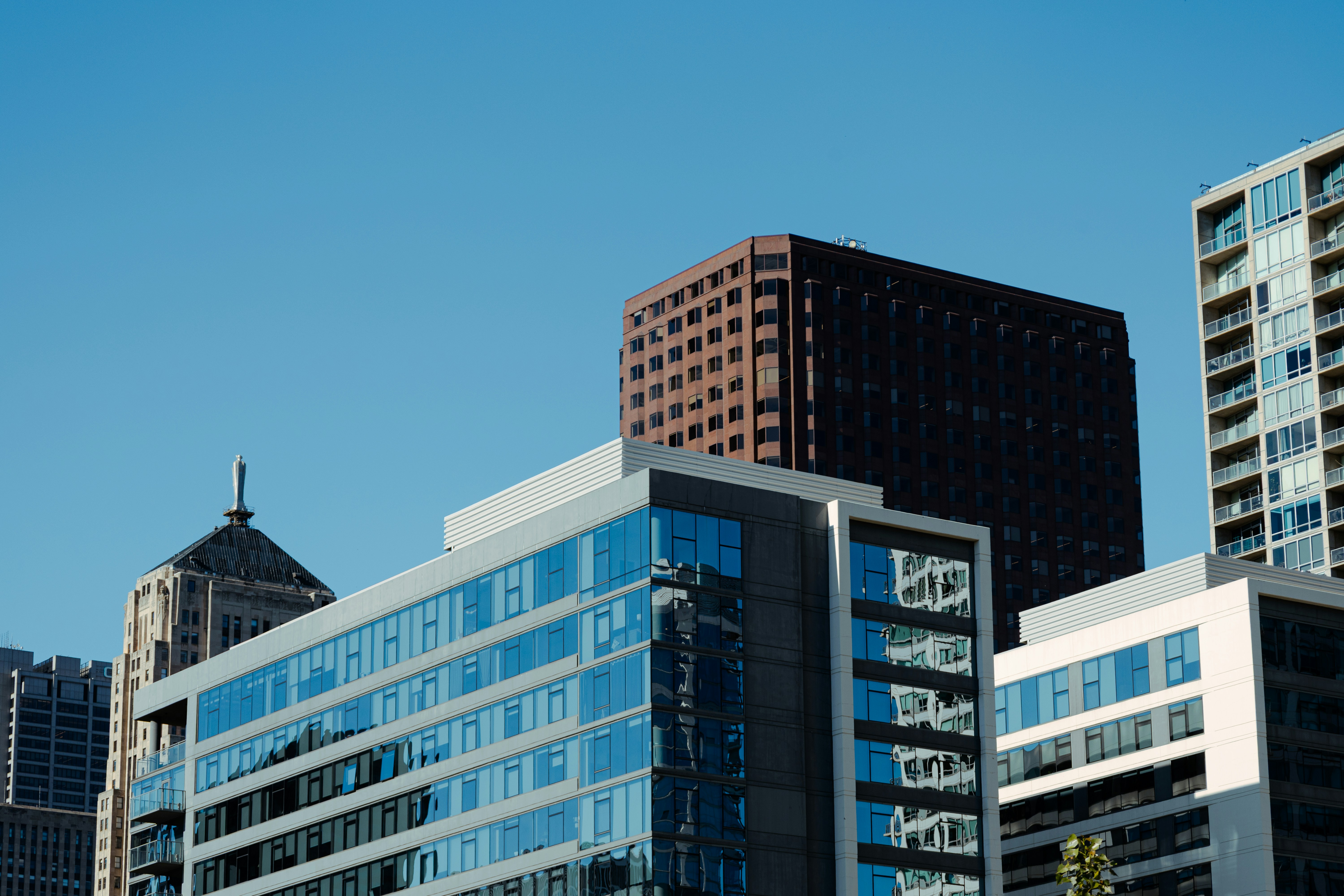 Blue-Glass Sky Over Angular City: Facades and Facets